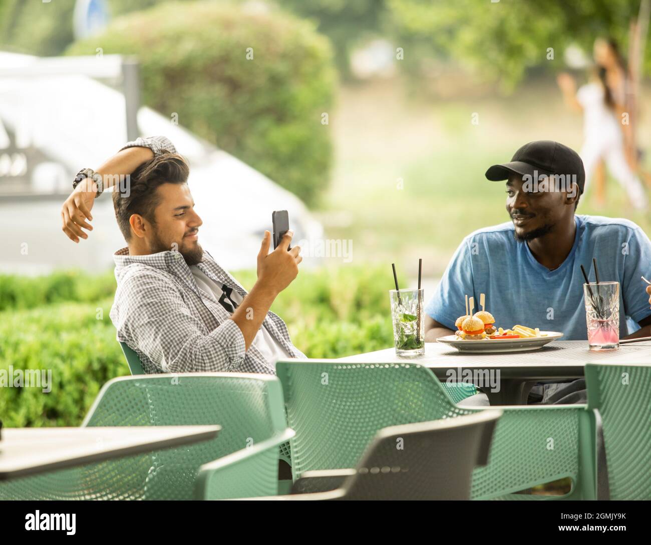 Diverse young friends talking via video call outdoors Stock Photo - Alamy