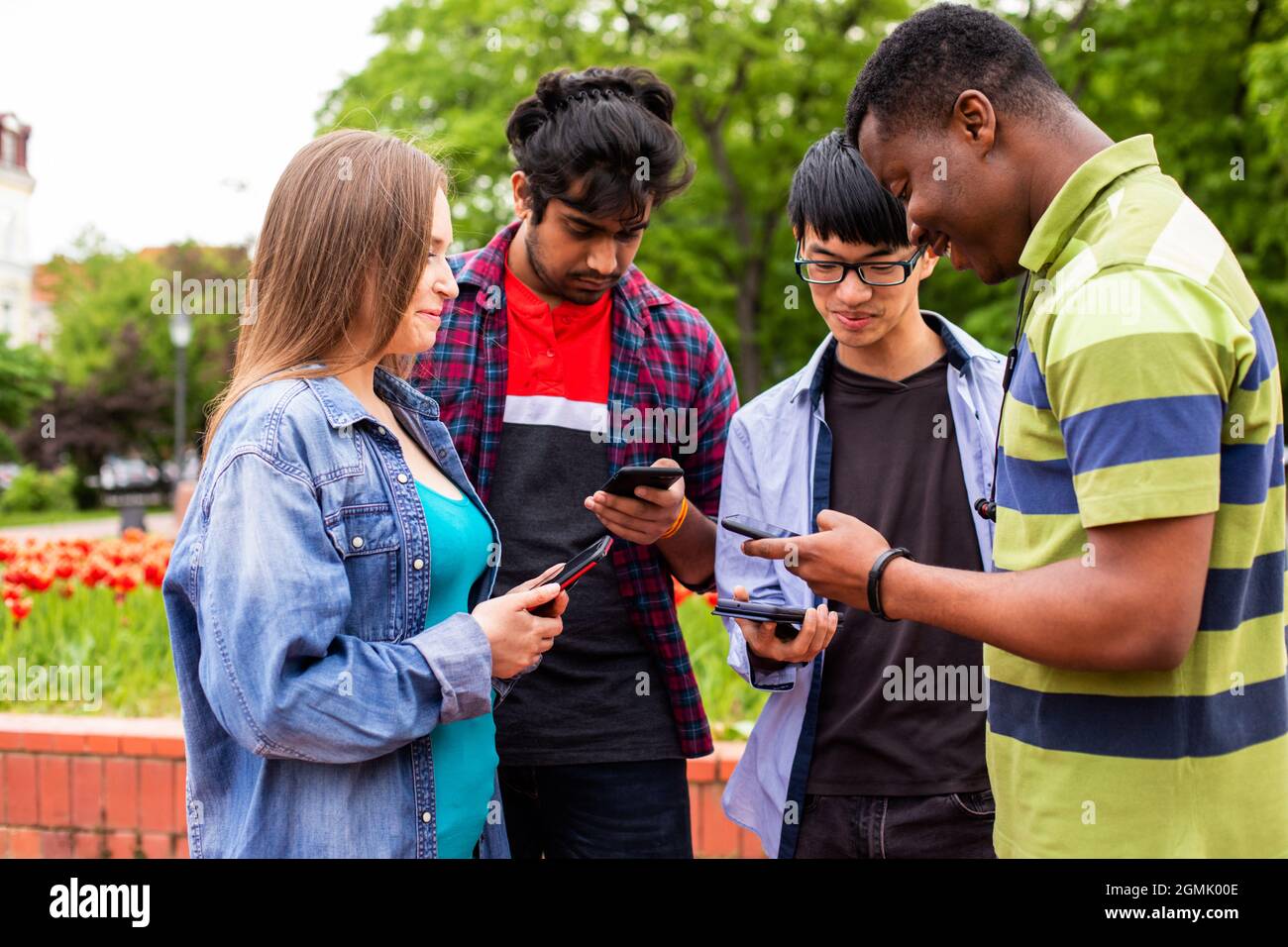 Multiethnic university students checking information using mobile ...