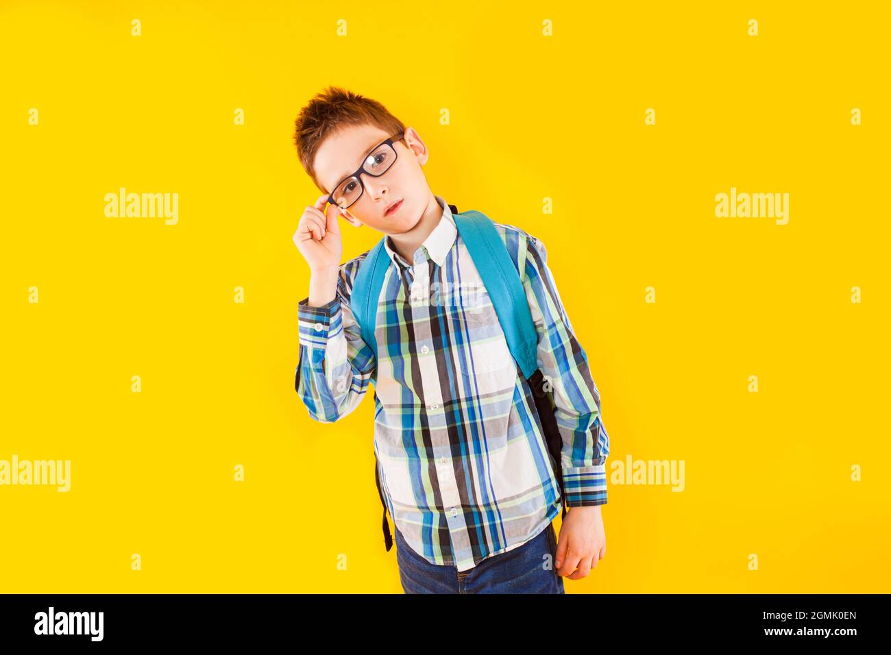The smart schoolboy shows thumbs up in studio Stock Photo - Alamy