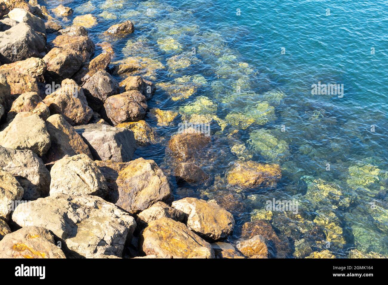 The stone coast of the sea with clear water. Seashore. Close up Stock ...