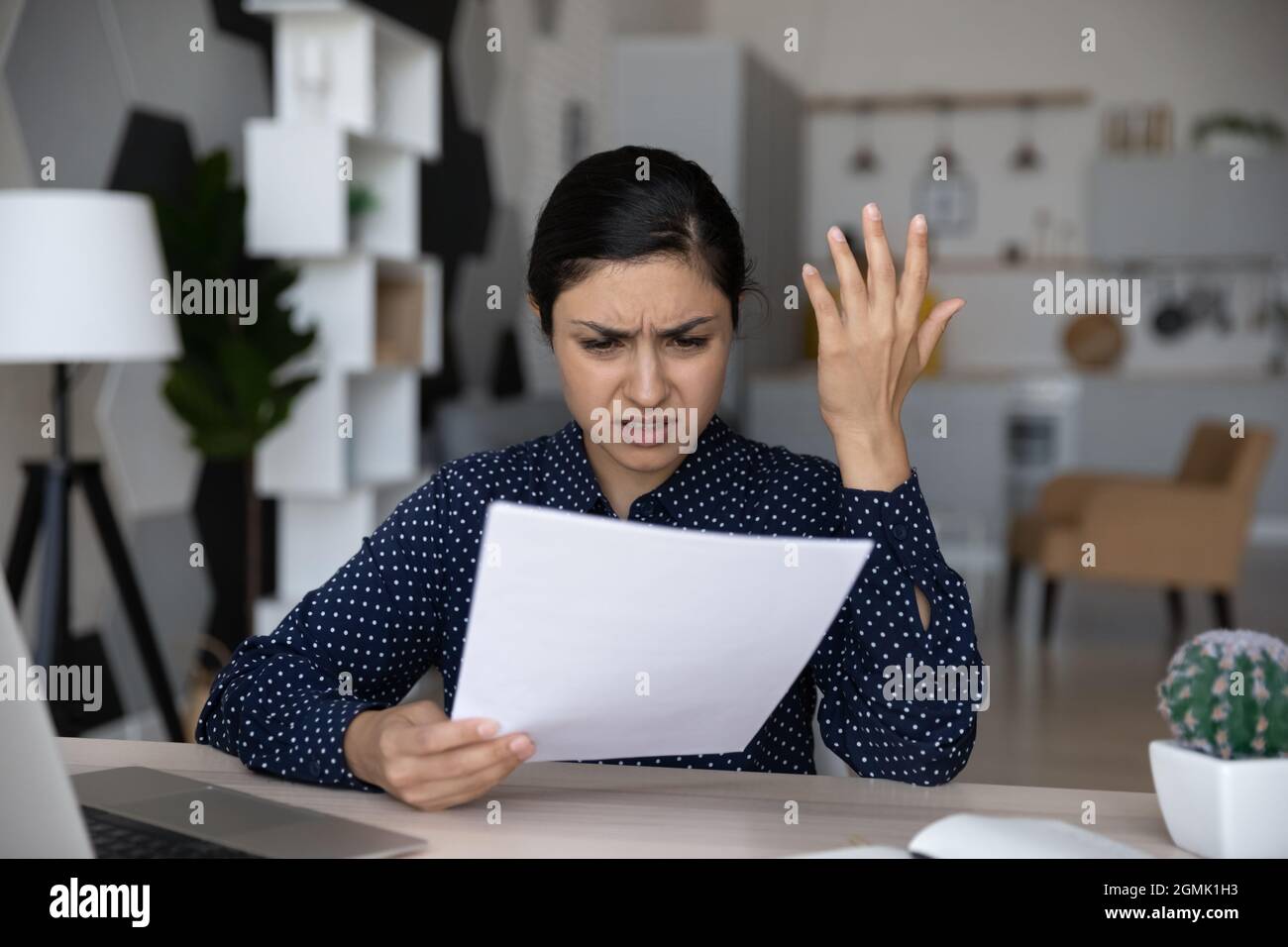 Unhappy annoyed Indian woman reading bad news in letter Stock Photo - Alamy