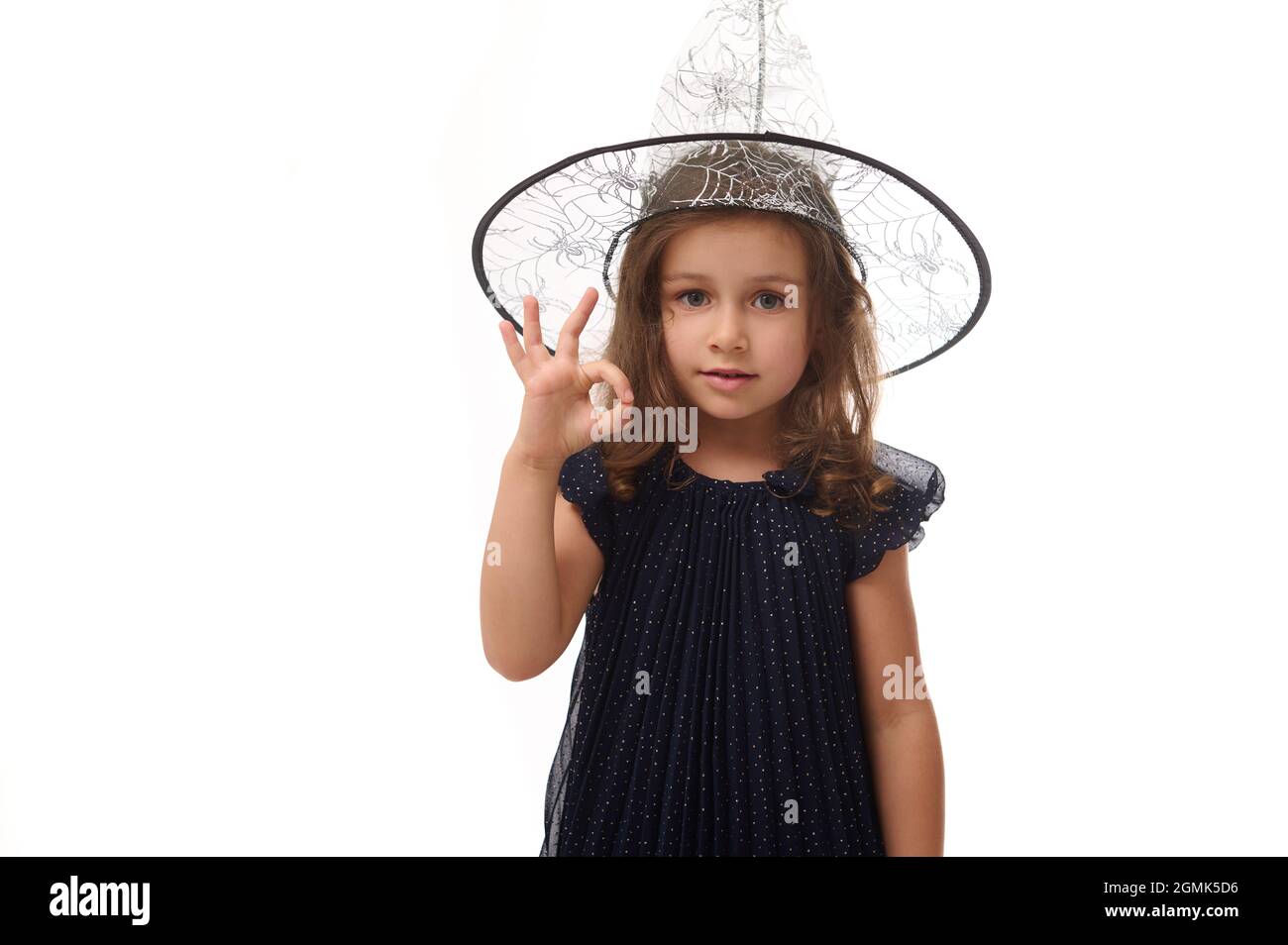 Isolated waist length portrait of pretty little witch girl wearing a ...