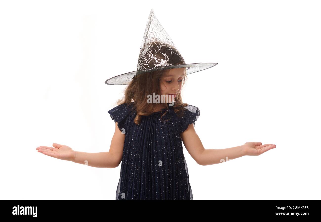 Halloween concept. Portrait of pretty little witch girl wearing wizard ...