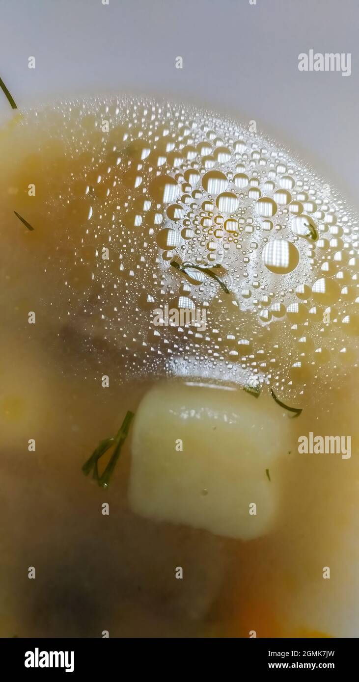 Drops of fat on the surface of the broth with reflections, macro Stock ...