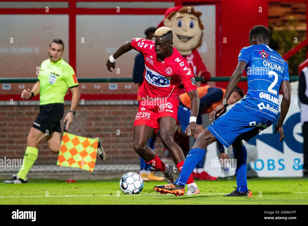 Kortrijk's Pape Habib Gueye and Gent's Joseph Okumu fight for the ball during a soccer match ...