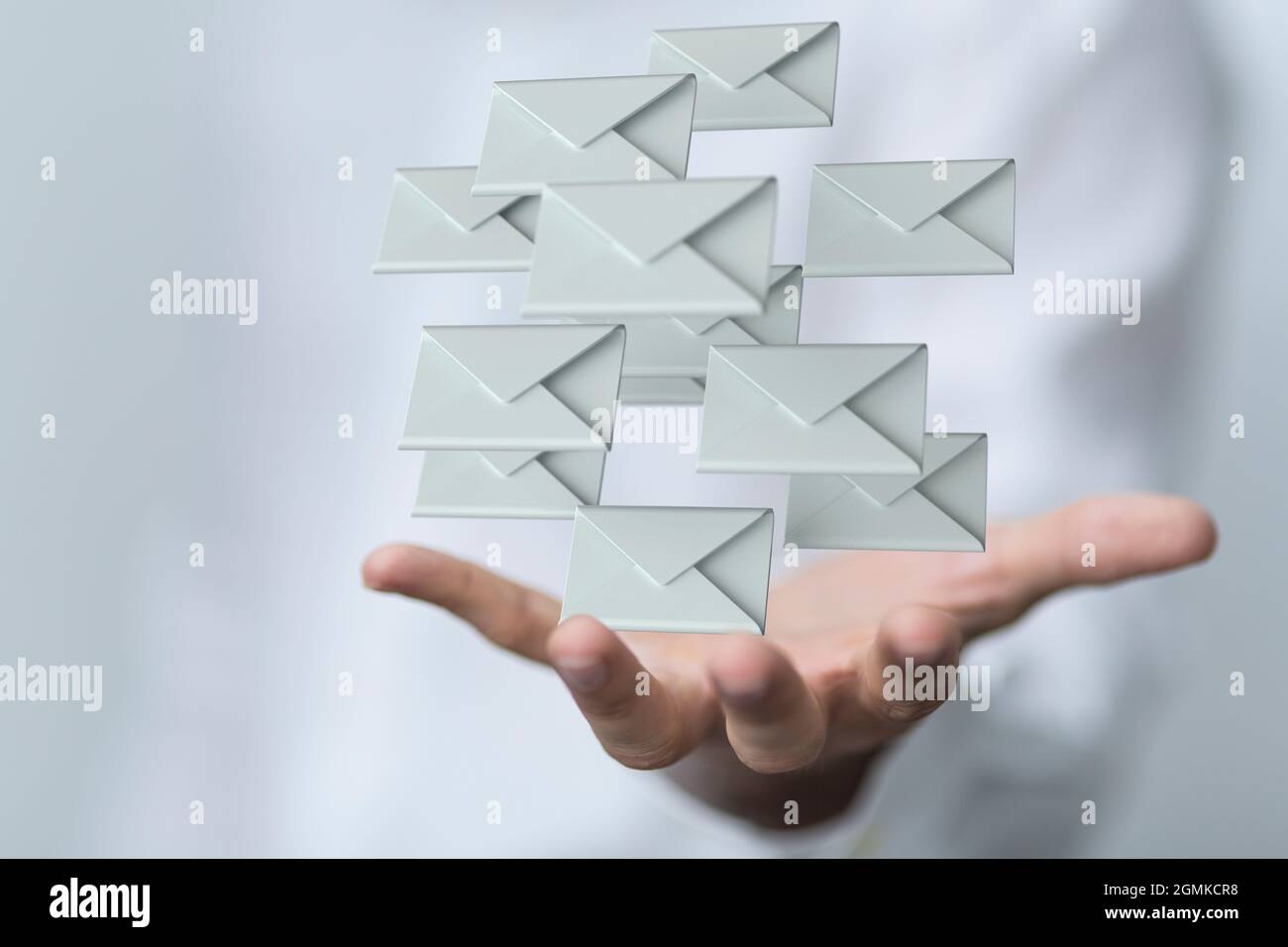 A 3D rendering of emails in a hand; electronic communication concept ...