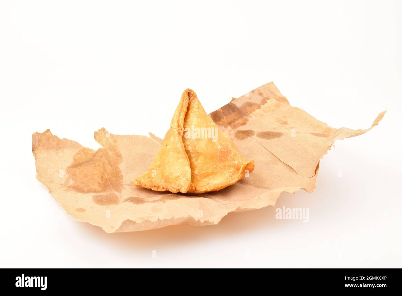 samosa on brown paper over white background Stock Photo - Alamy