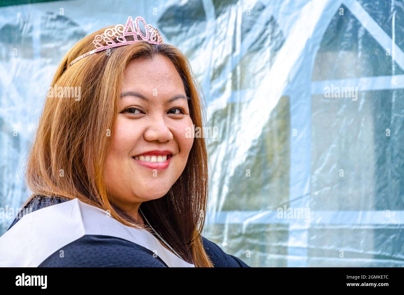 An attractive lady poses for photos wearing a 40th birthday tiara Stock ...