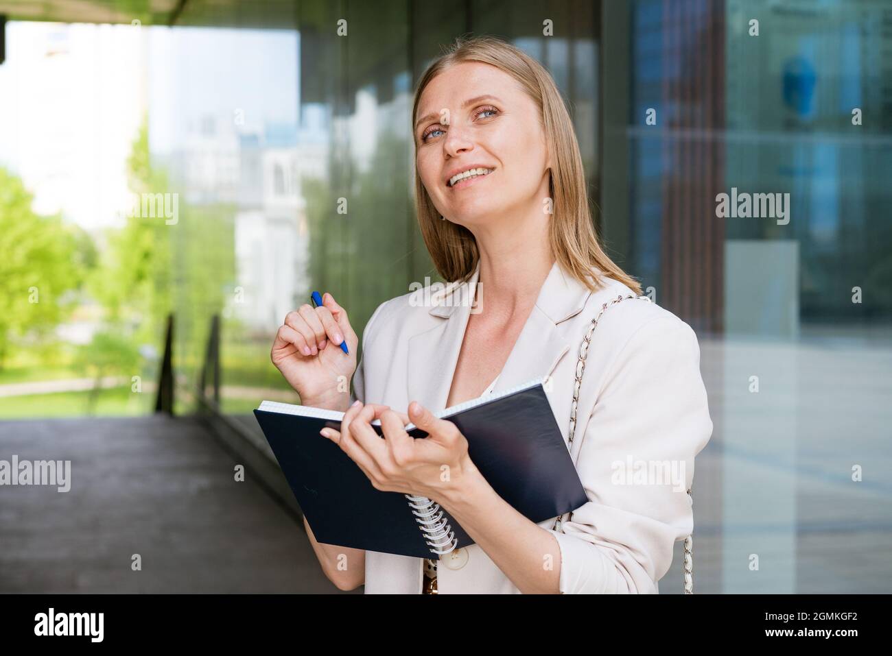 Business woman writing with pen in notebook. Caucasian successful girl ...