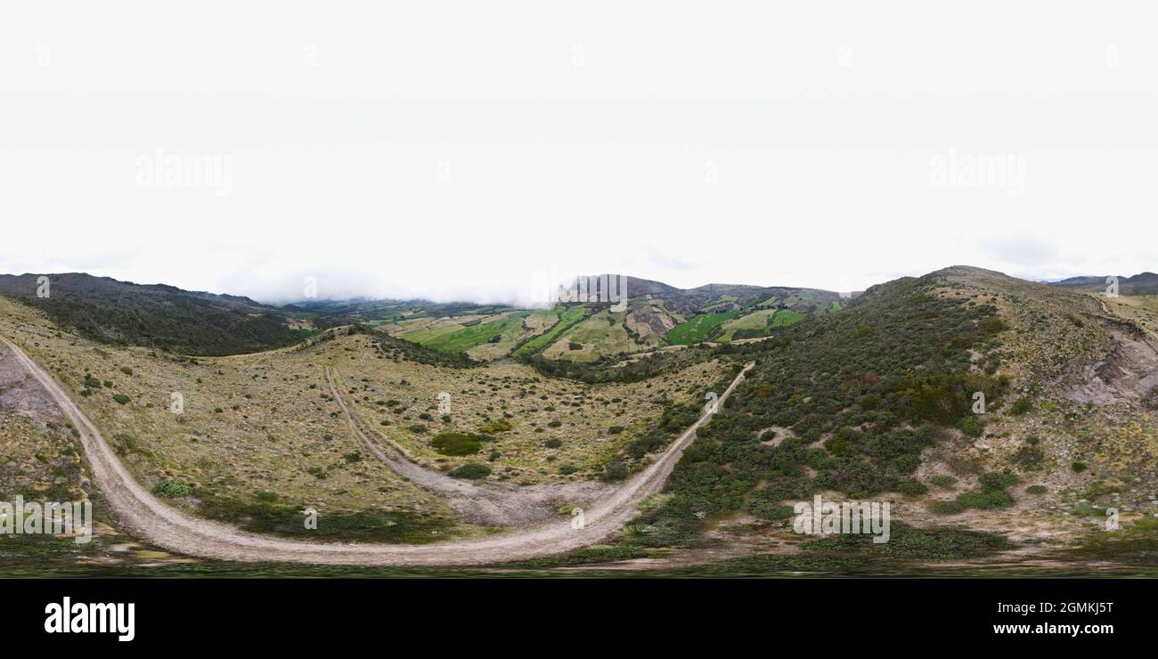 A beautiful landscape with a road surrounded by green lands and misty ...