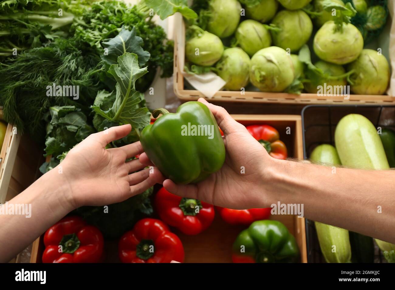 Young couple choosing vegetables in market Stock Photo - Alamy
