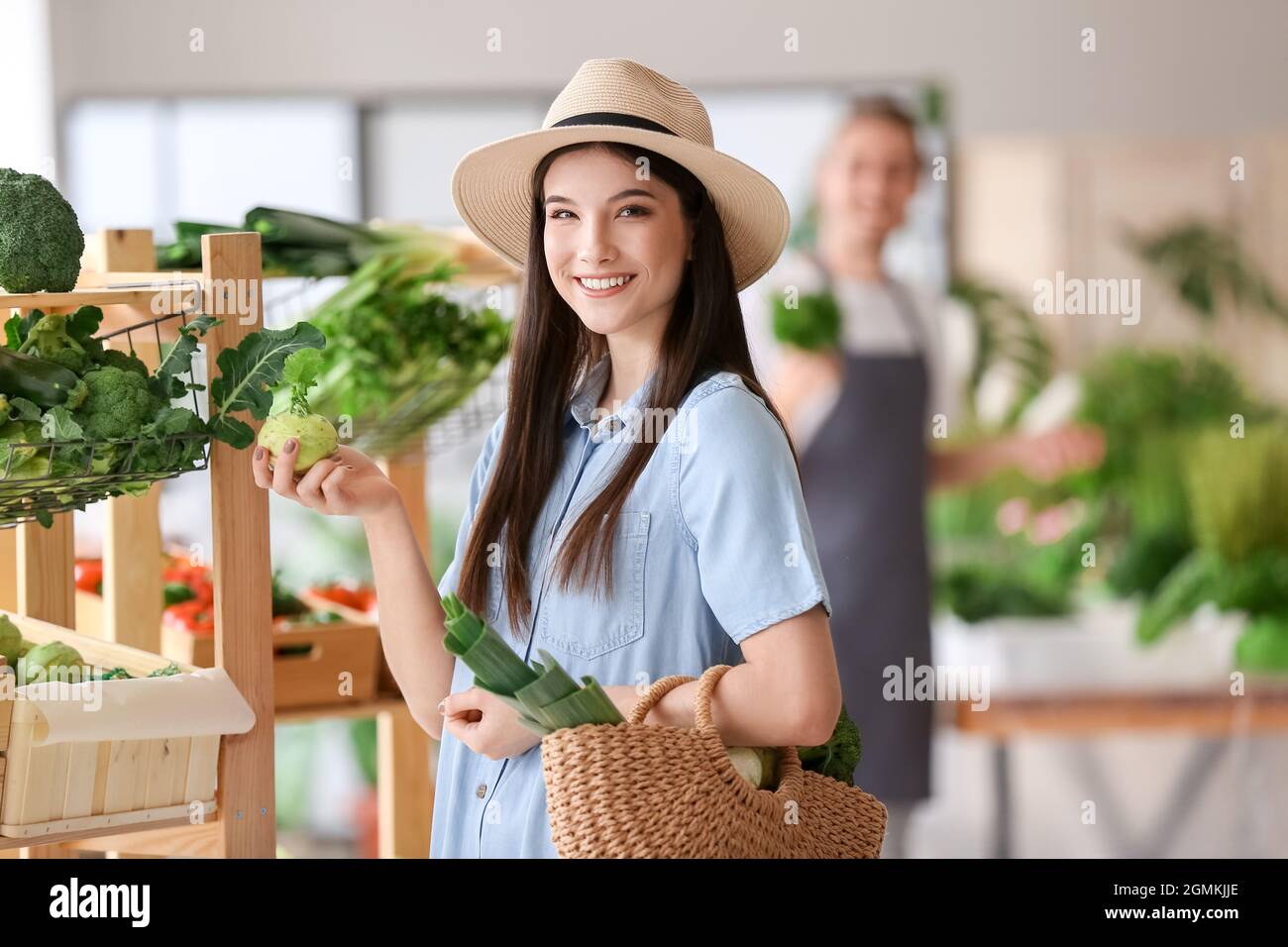 Young woman choosing vegetables in market Stock Photo - Alamy