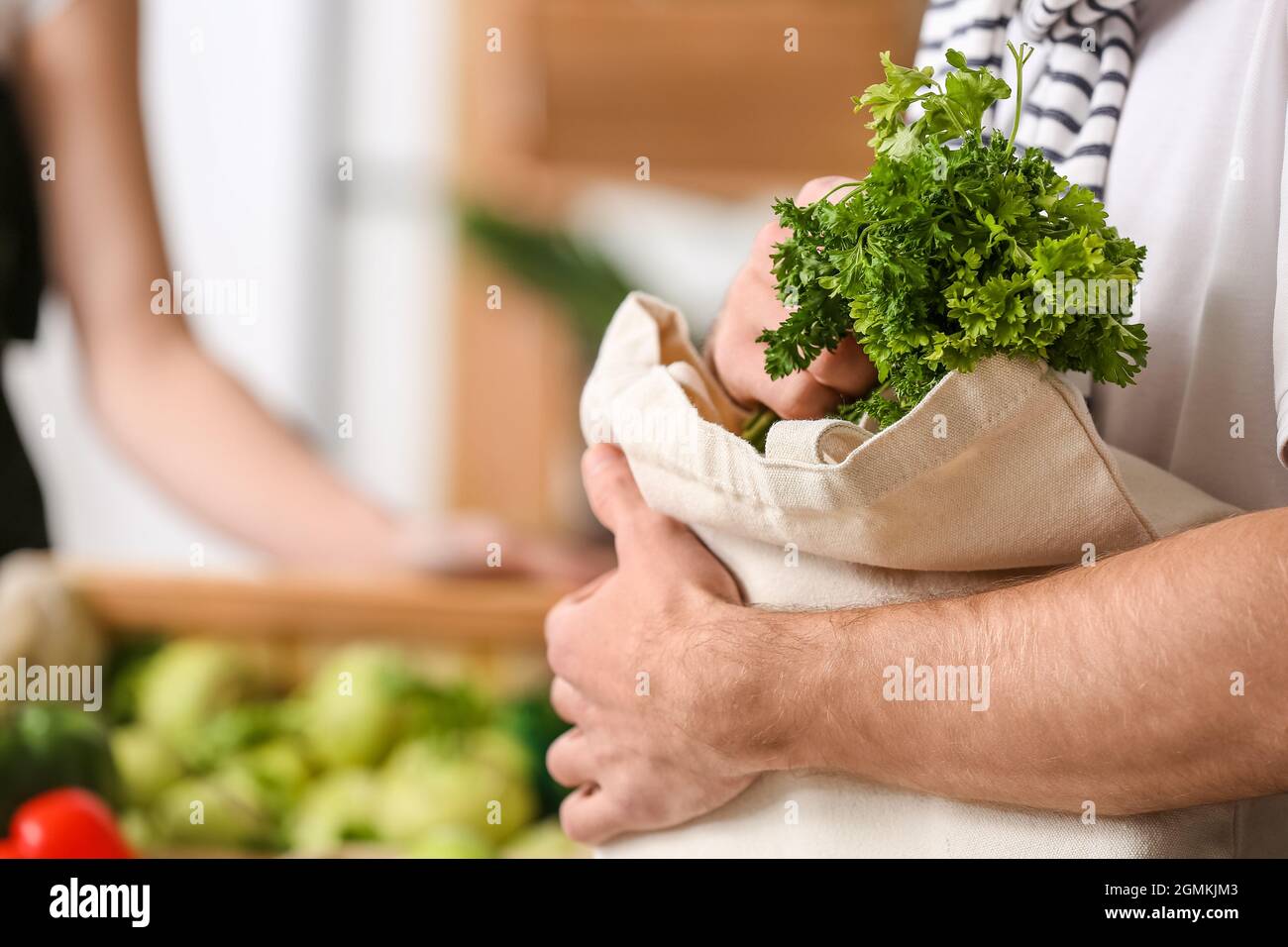 Young man choosing vegetables in market Stock Photo - Alamy