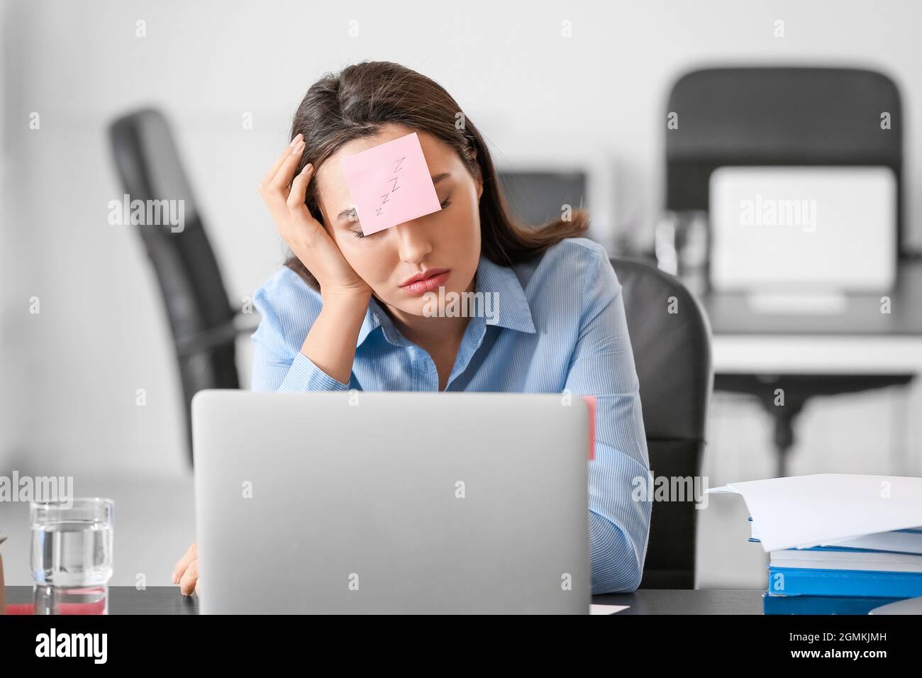 Young woman sleeping at workplace in office Stock Photo - Alamy