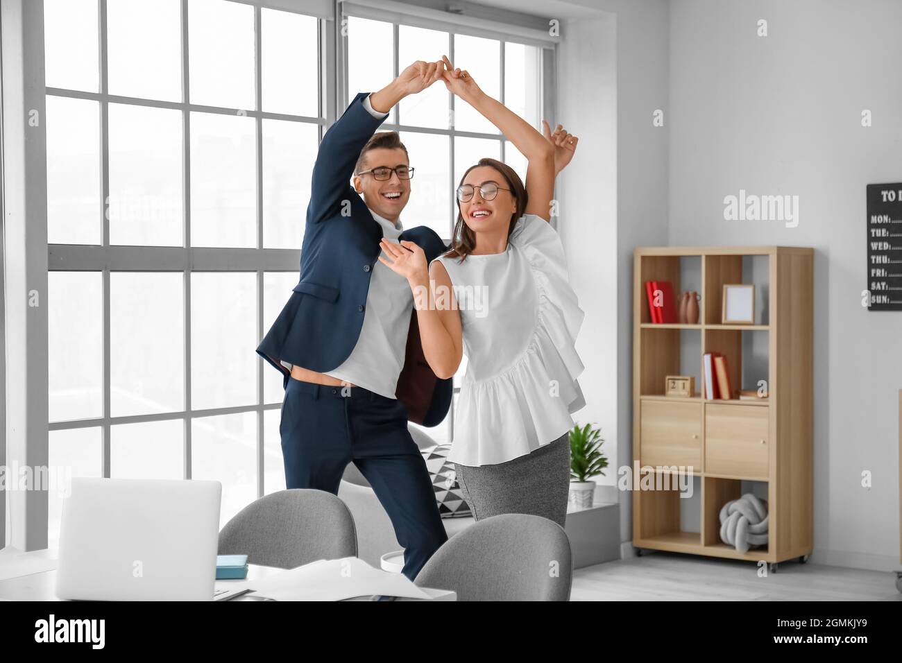 Happy colleagues having fun in office Stock Photo - Alamy