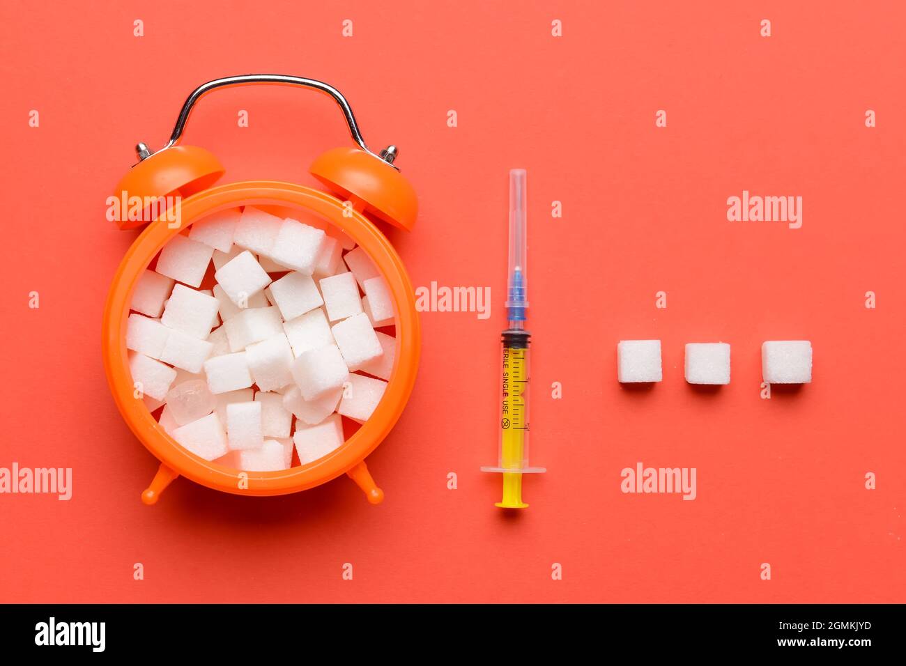 Alarm clock with sugar and syringe on color background Stock Photo - Alamy