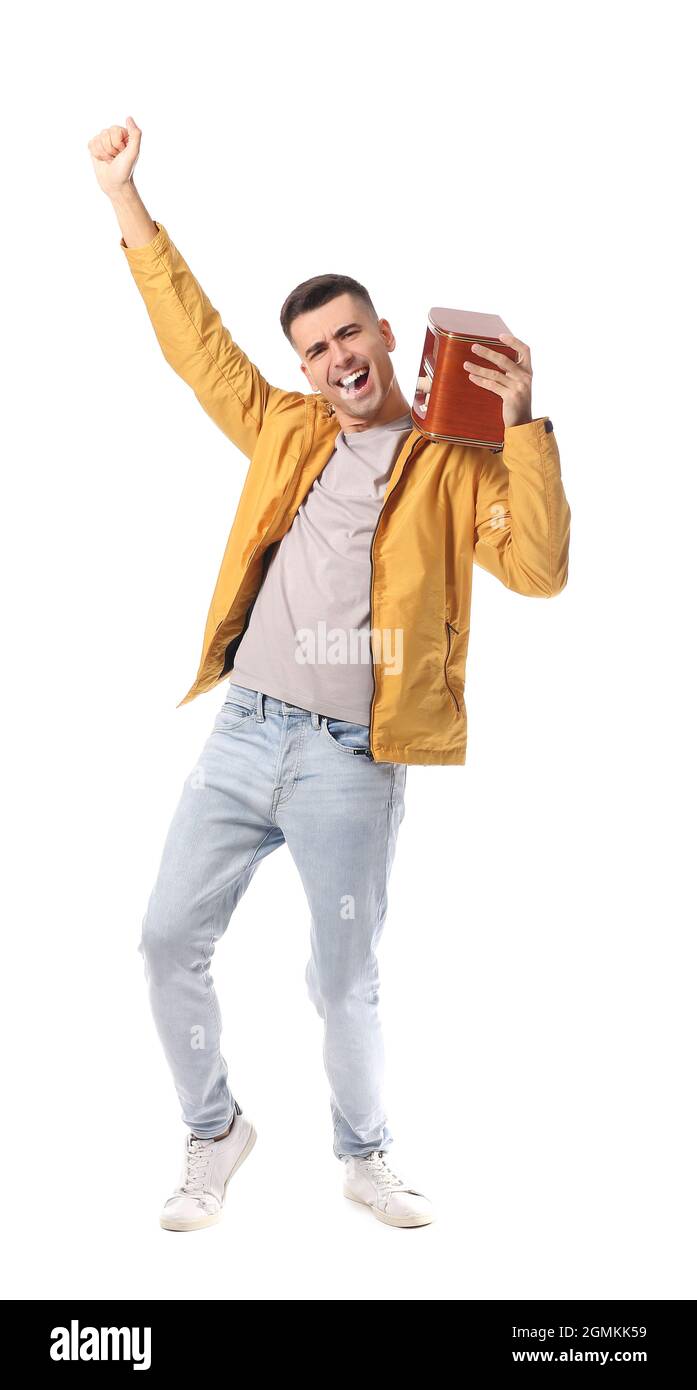 Young man with retro radio receiver dancing on white background Stock ...