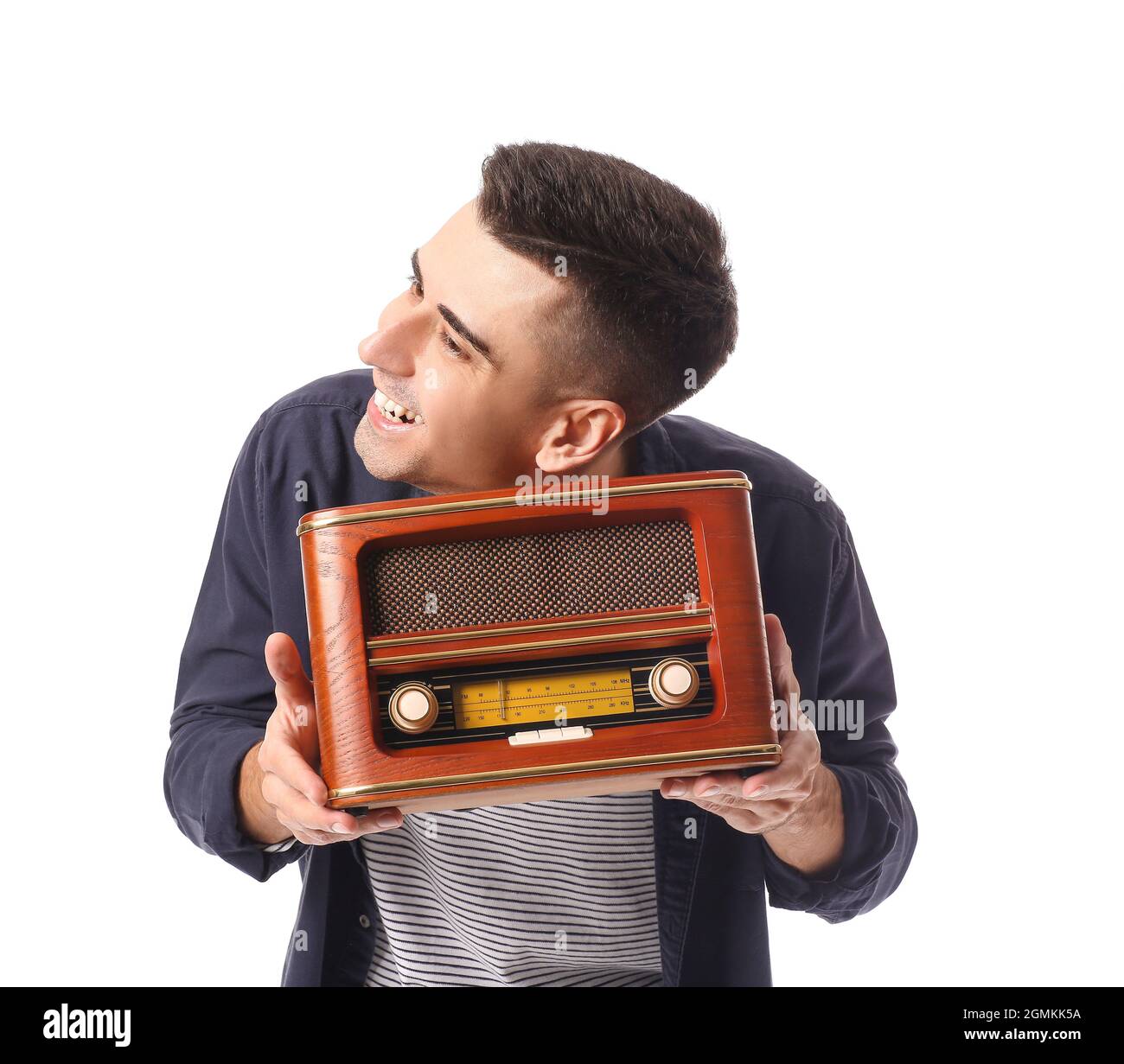 Handsome young man with retro radio receiver on white background Stock ...