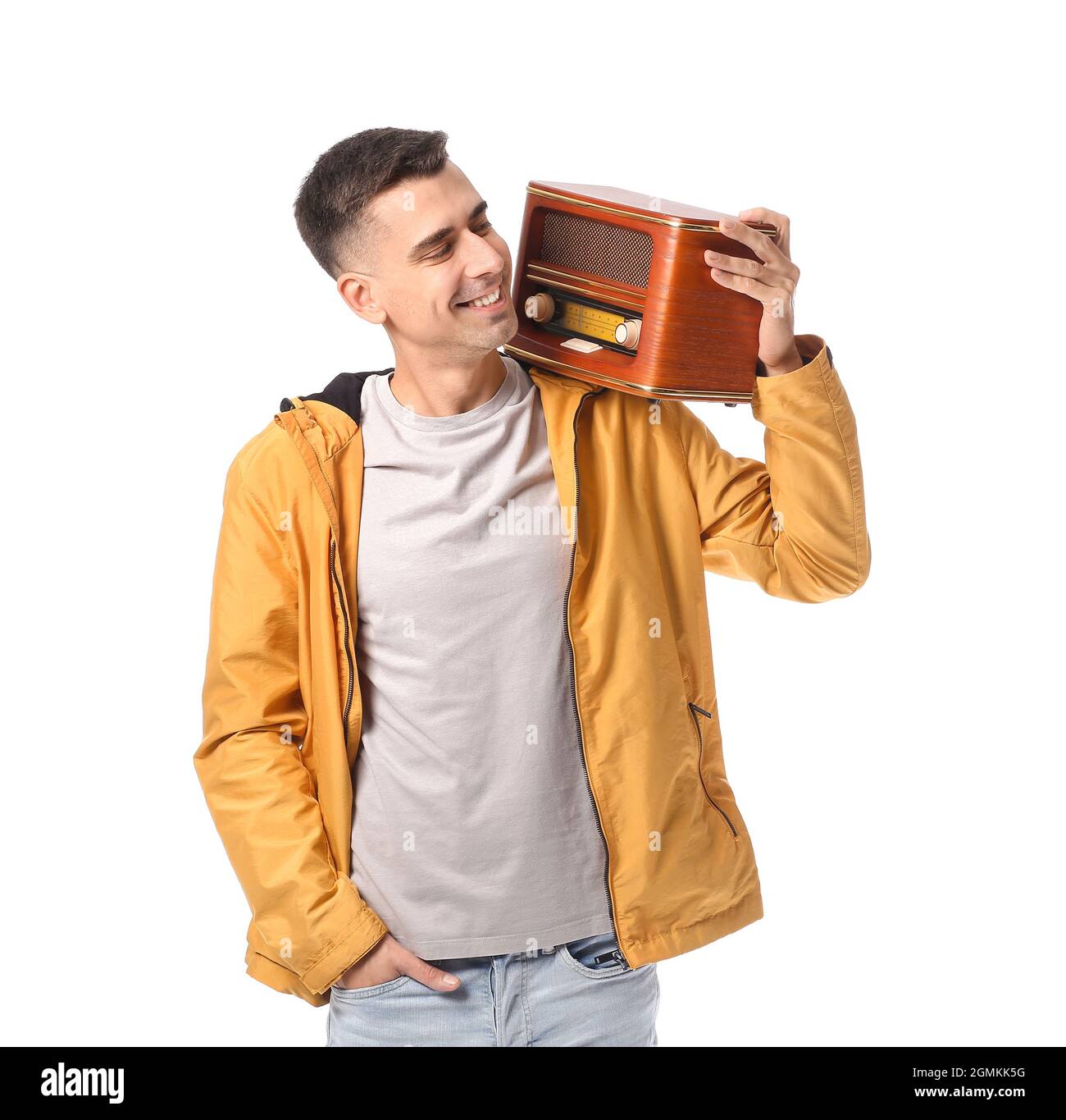 Handsome young man with retro radio receiver on white background Stock ...