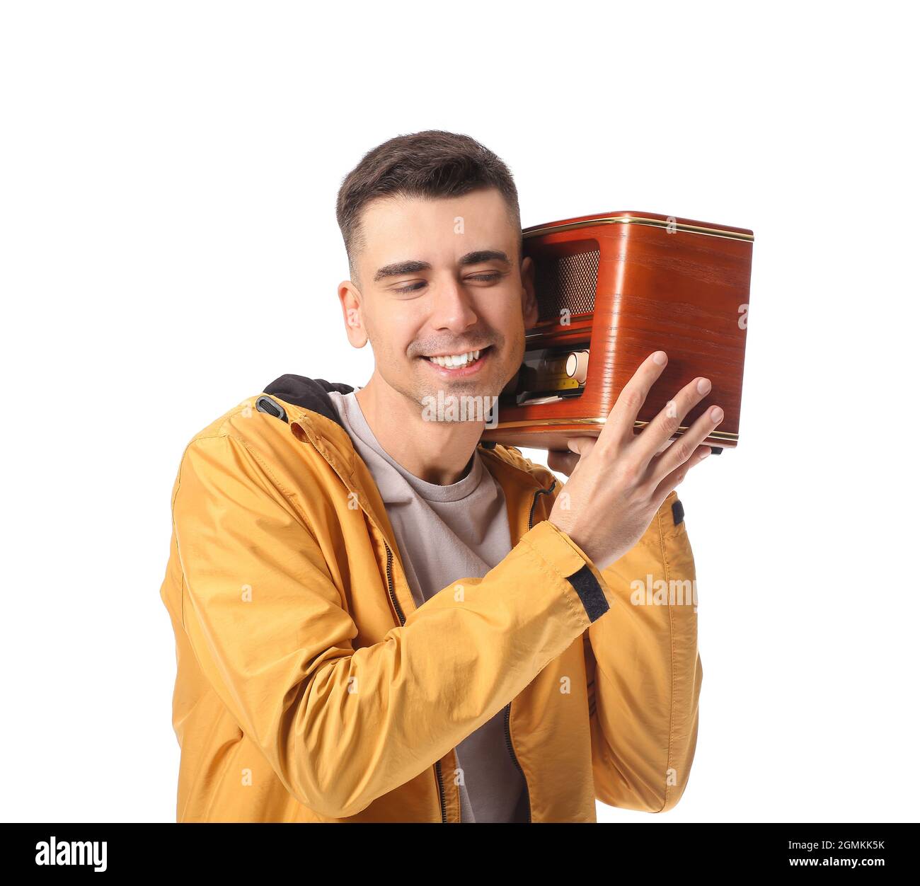 Handsome young man with retro radio receiver on white background Stock ...
