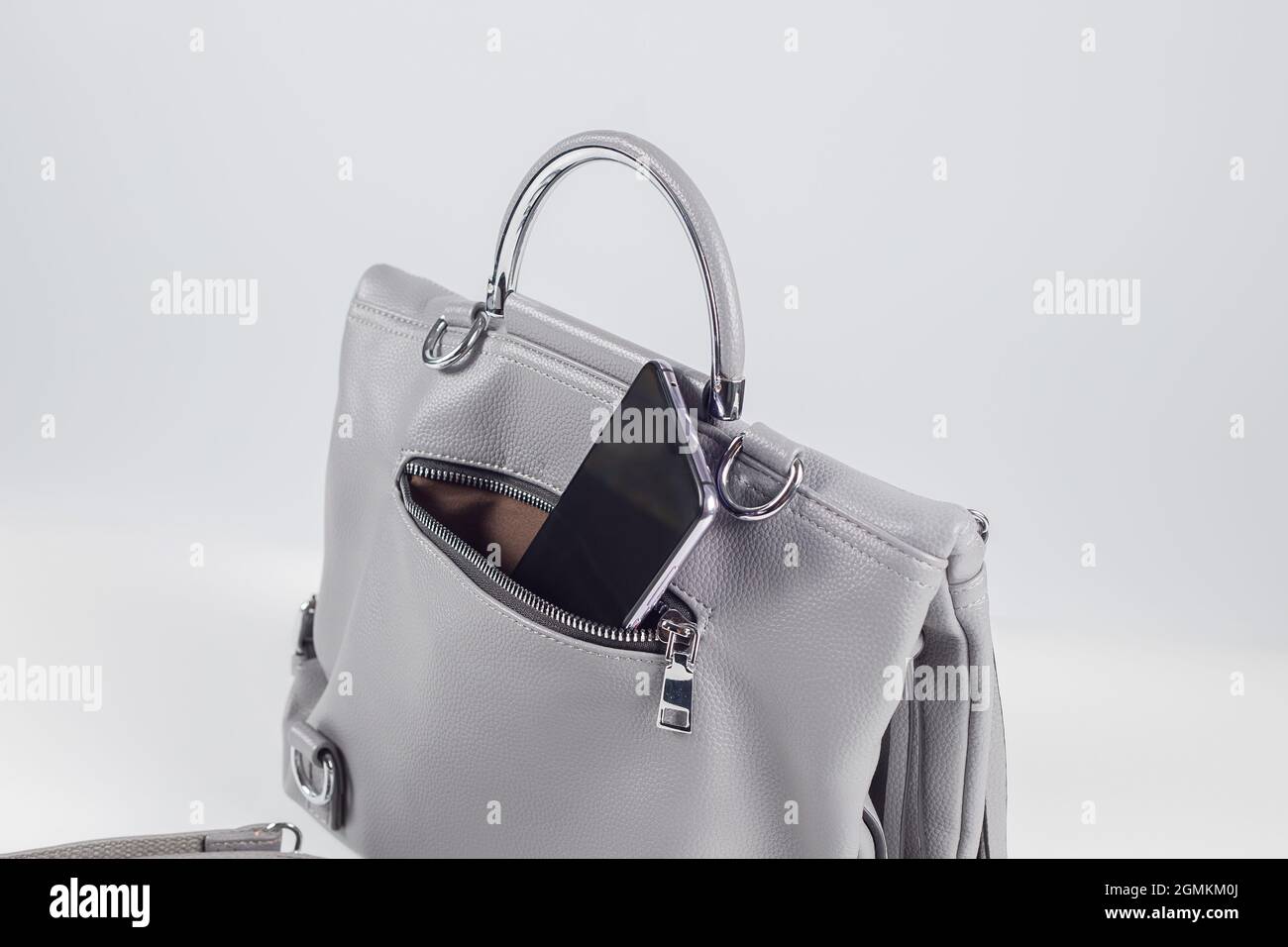smartphone in open pocket of bag on white background Stock Photo - Alamy