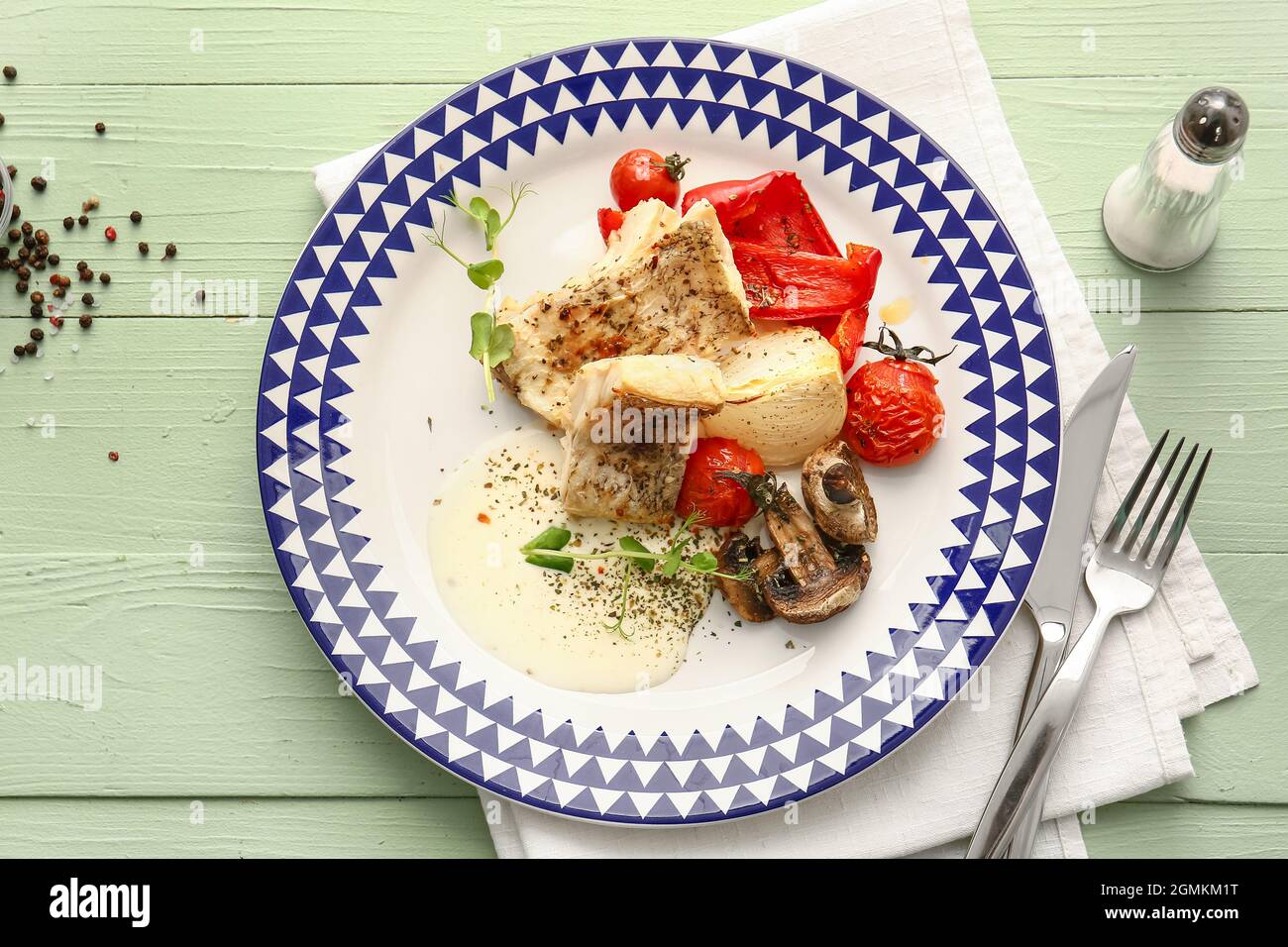 Plate with tasty baked cod fillet, vegetables and mushrooms on color ...