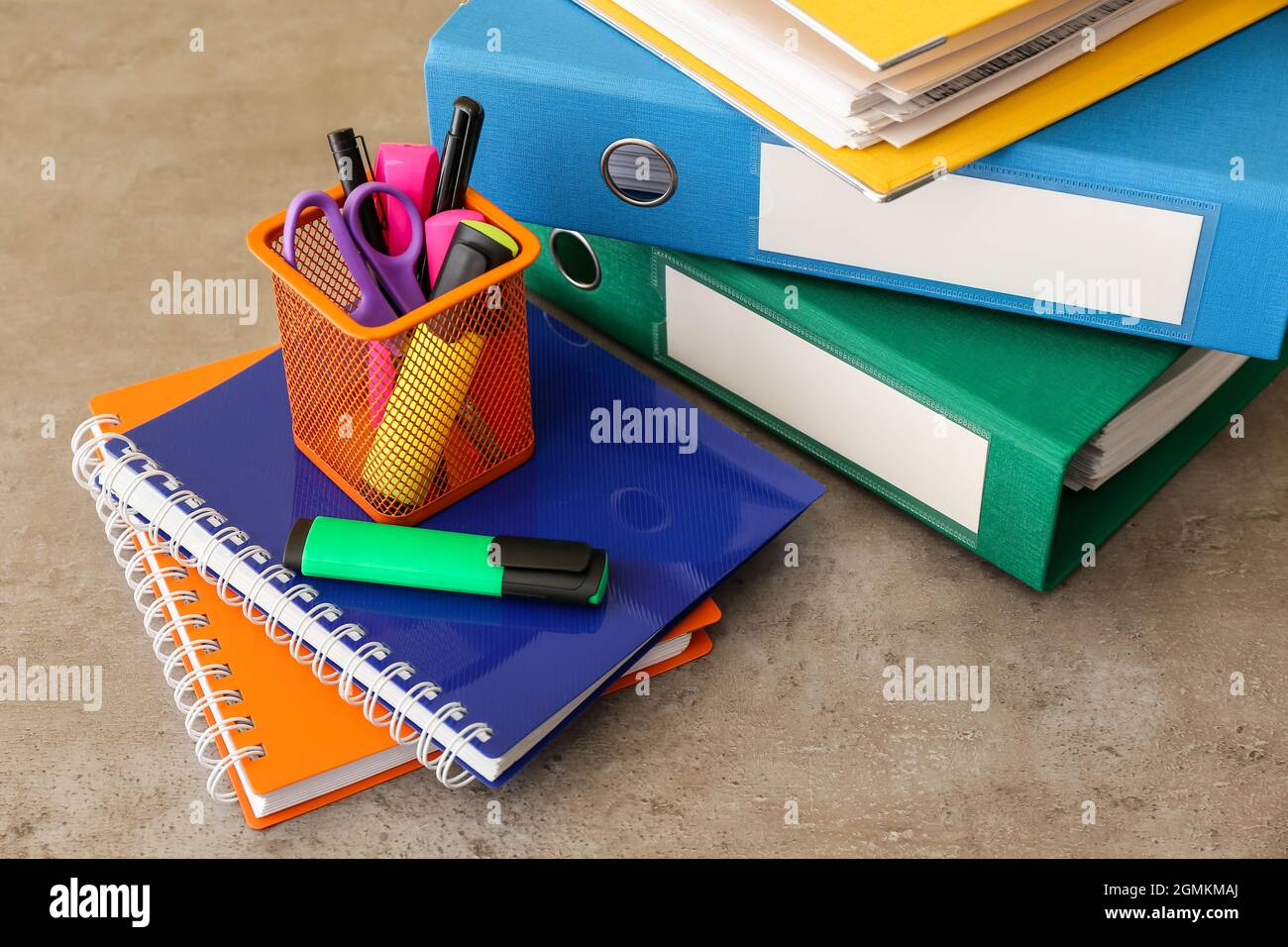 Office folders and stationery on grey background Stock Photo - Alamy