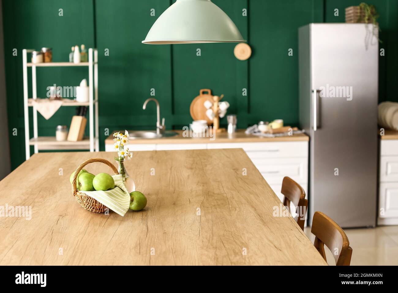 Interior of stylish kitchen with green apples on dining table Stock ...