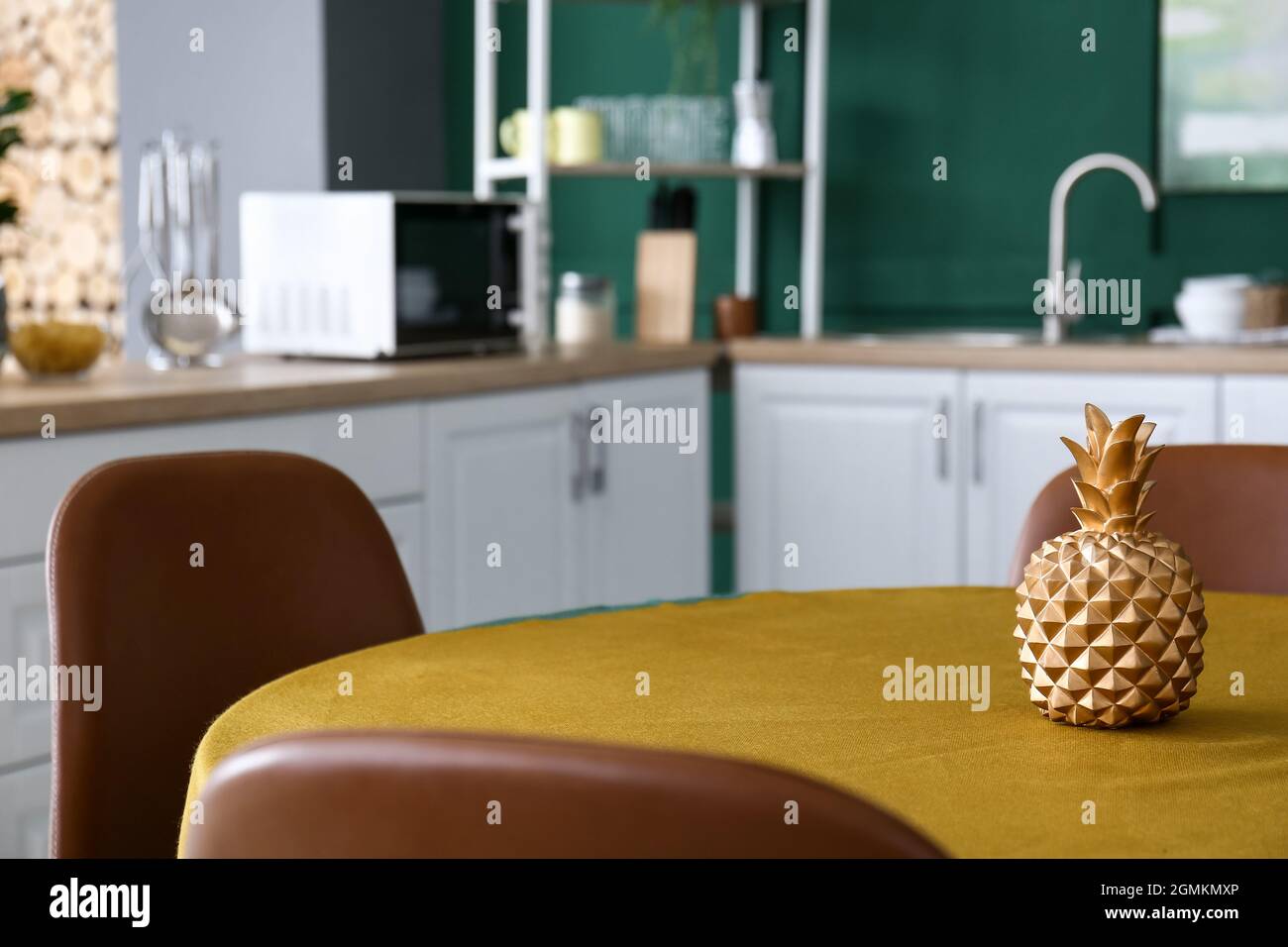 Golden pineapple stylish decor on dining table in modern kitchen Stock ...