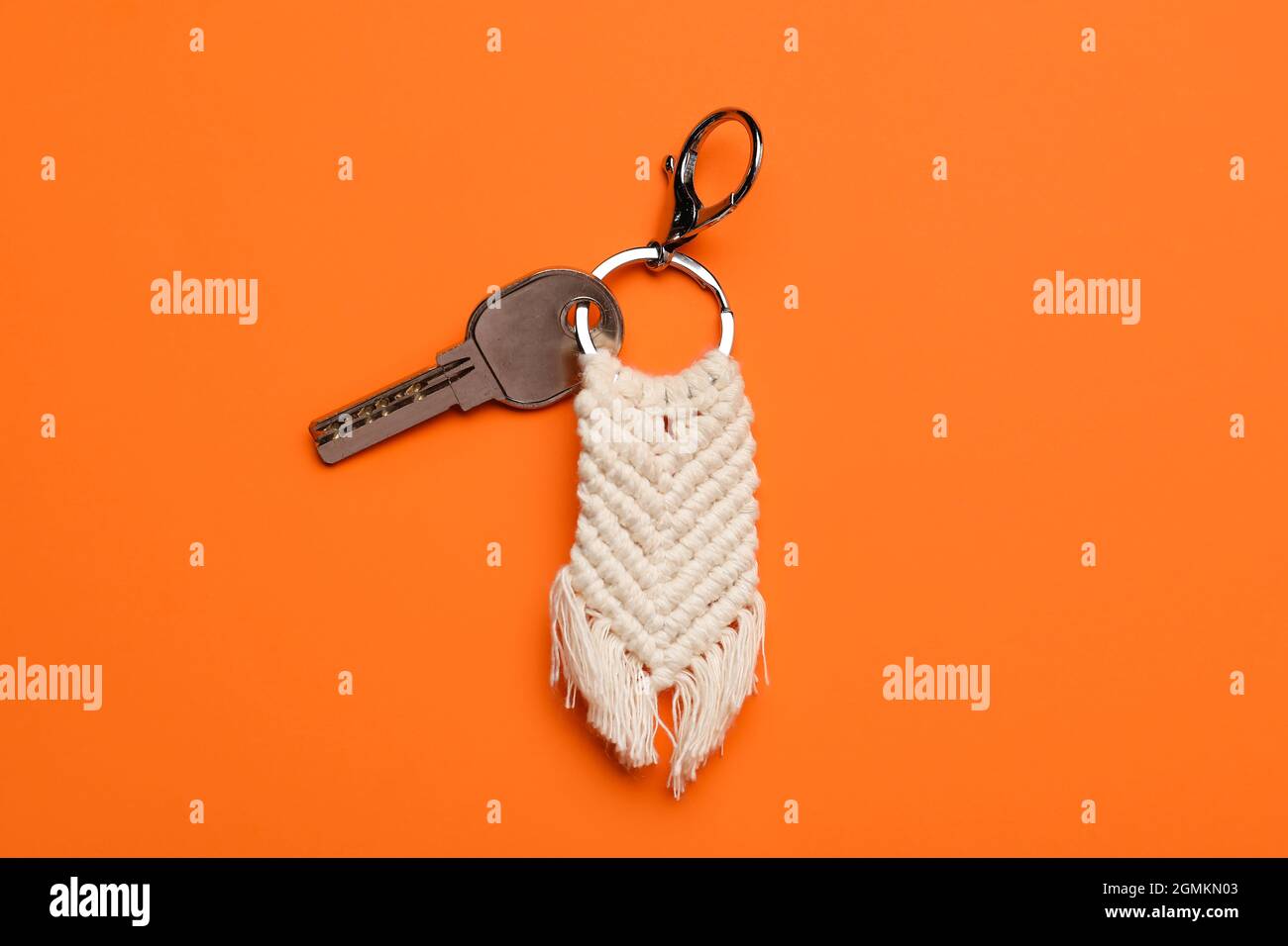 Key with handmade cotton keychain on color background Stock Photo - Alamy