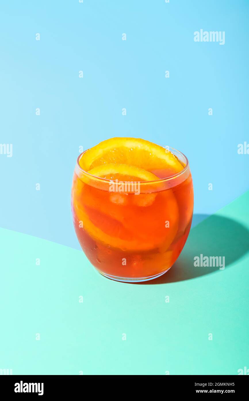 Glass of Aperol spritz cocktail on color background Stock Photo - Alamy