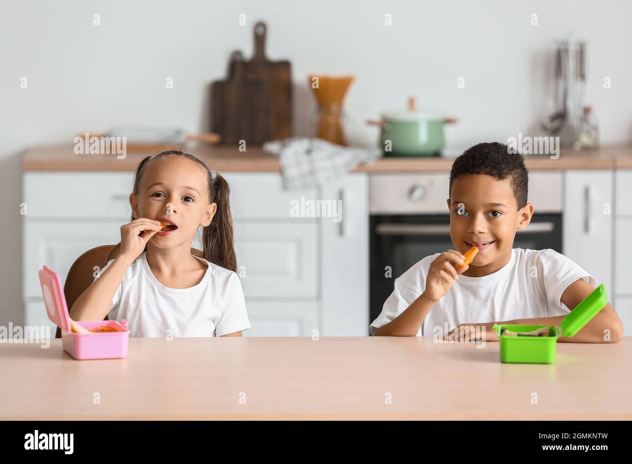 Cute children having lunch at home Stock Photo - Alamy