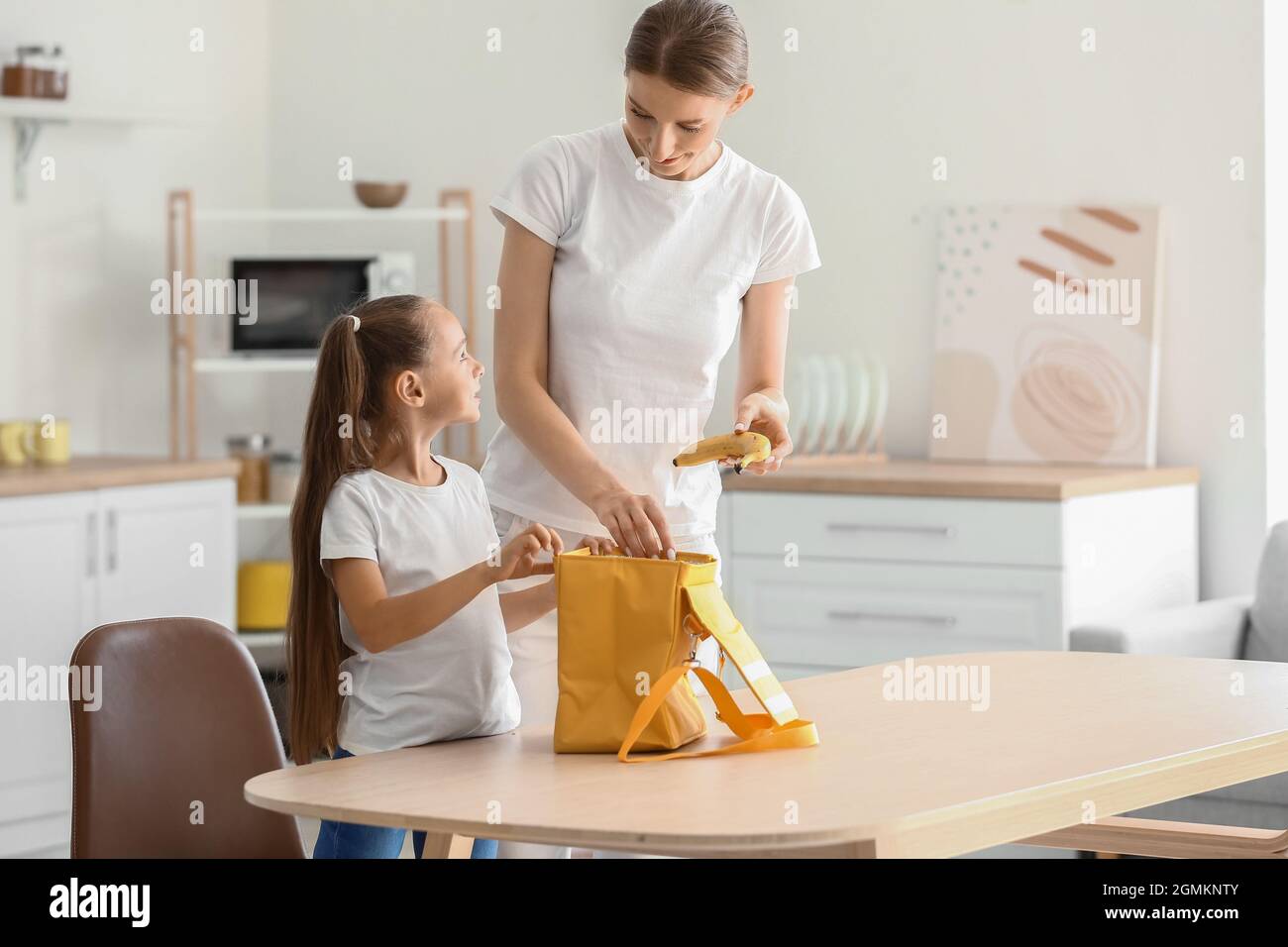 Girl packing lunch mother hi-res stock photography and images - Alamy