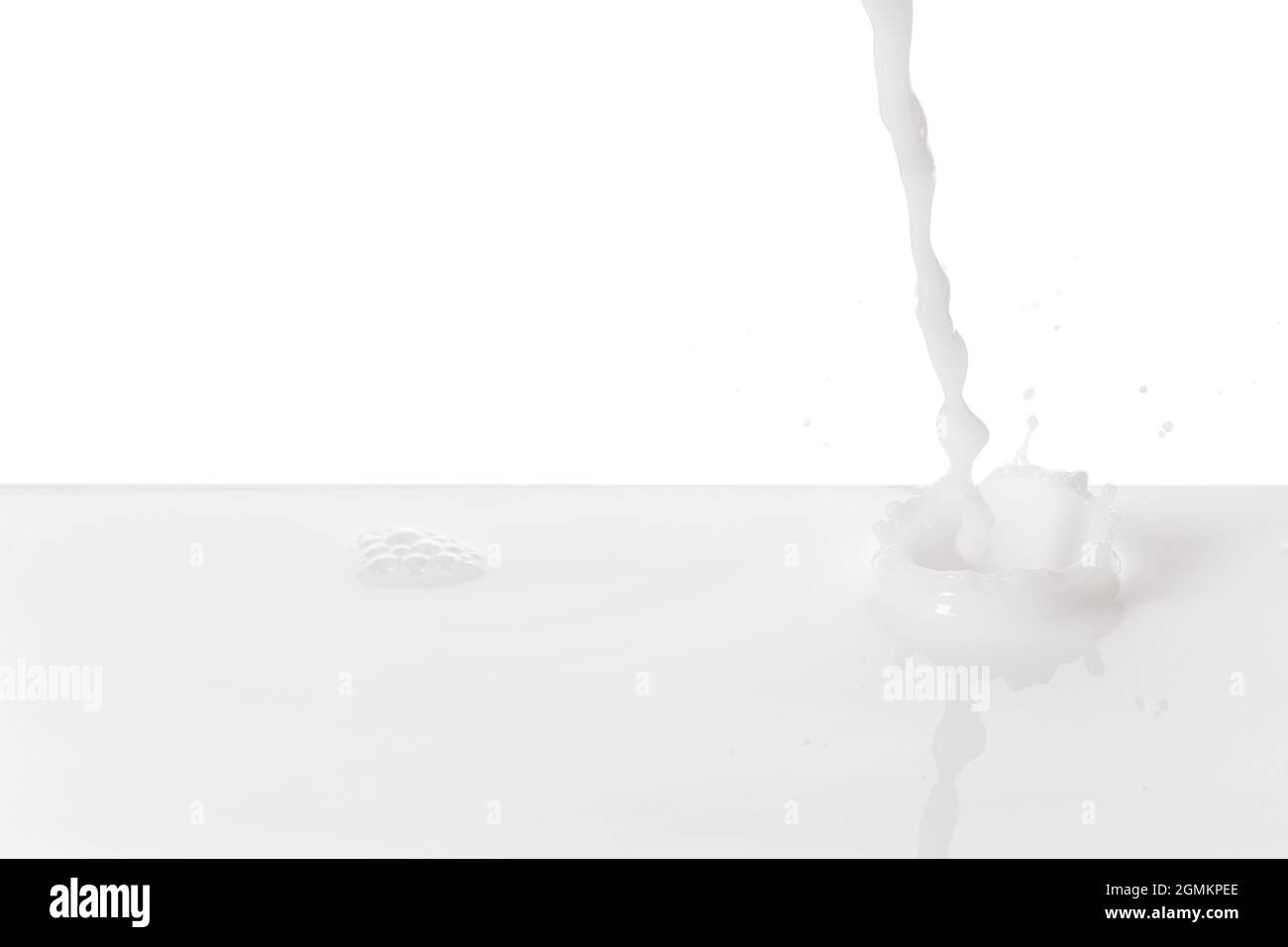 Pouring delicious milk on white background Stock Photo - Alamy