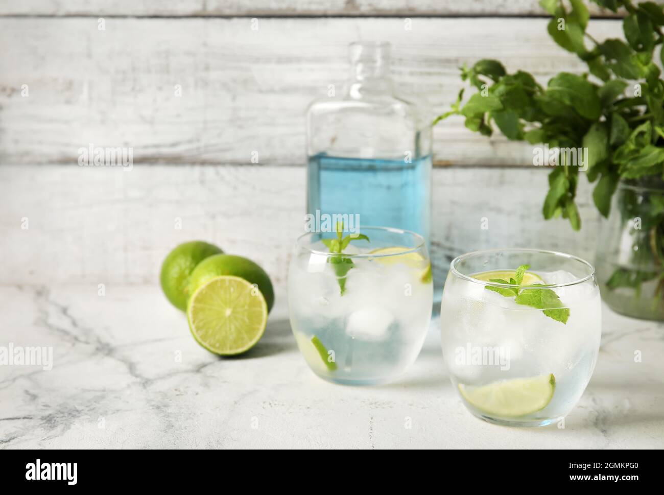 Glasses of cold gin tonic on light background Stock Photo - Alamy