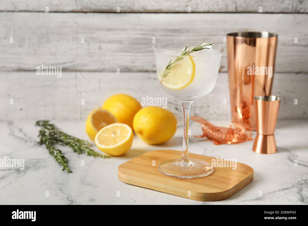 Glass of cold gin tonic on light background Stock Photo - Alamy