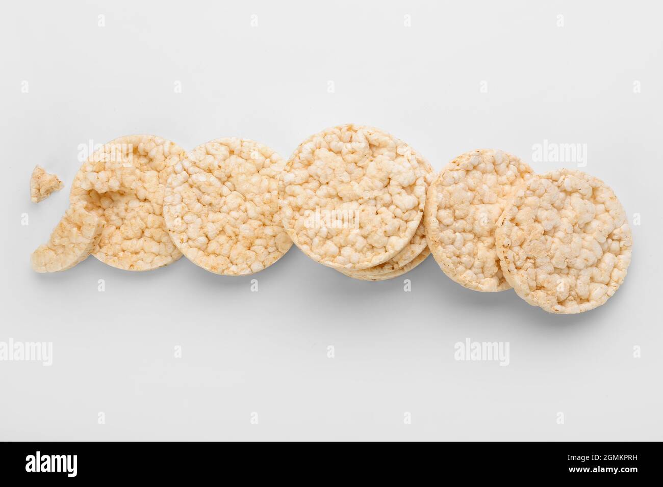 Pile of puffed rice crackers on white background Stock Photo - Alamy