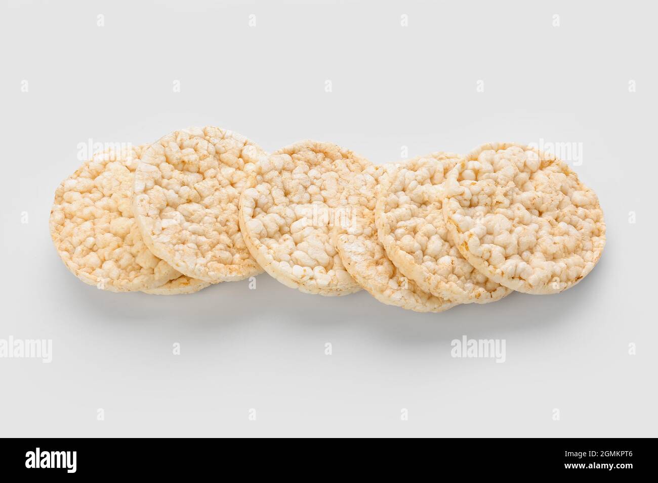 Puffed rice crackers on white background Stock Photo - Alamy