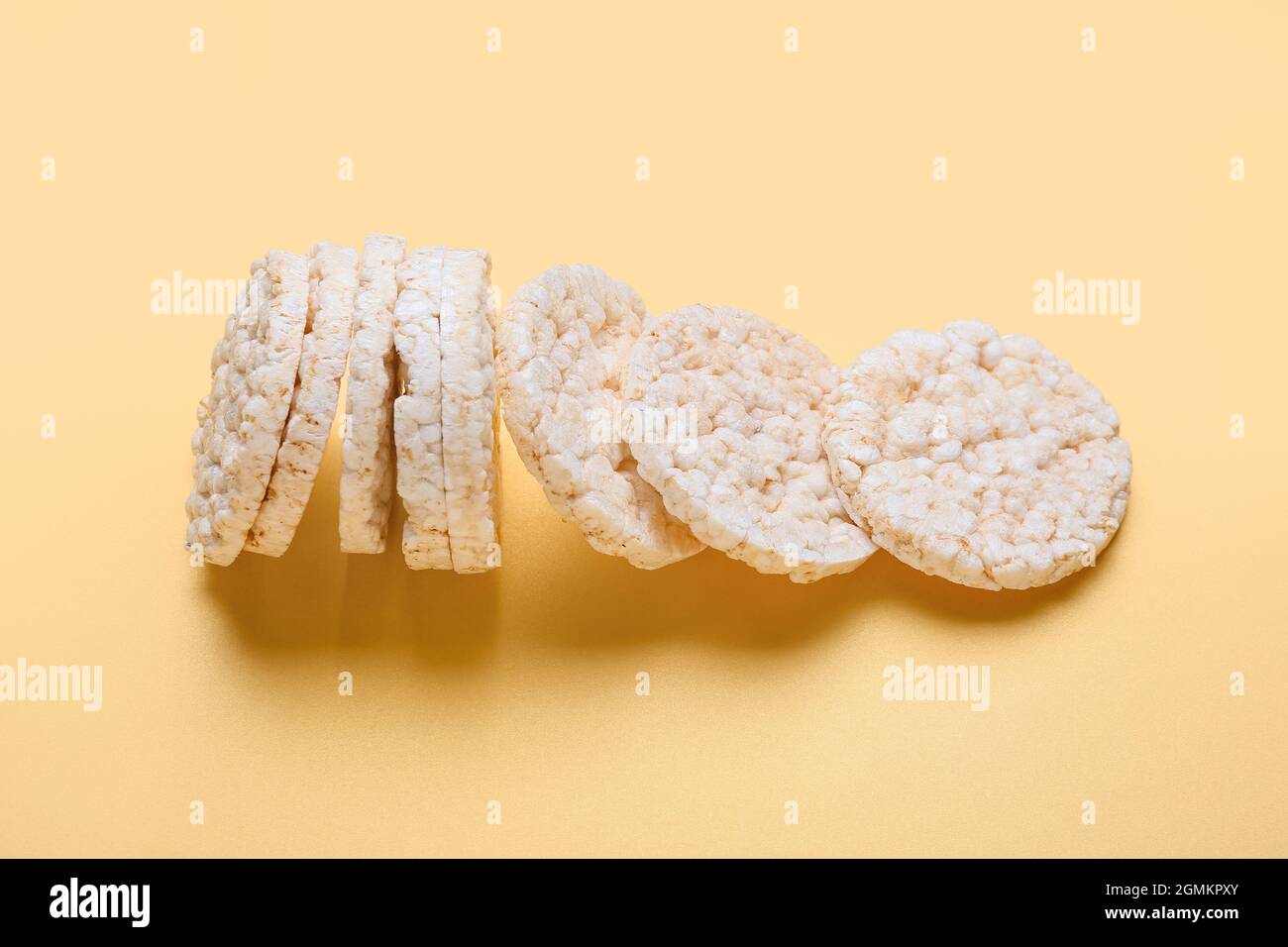 Puffed crispy rice crackers on color background Stock Photo - Alamy