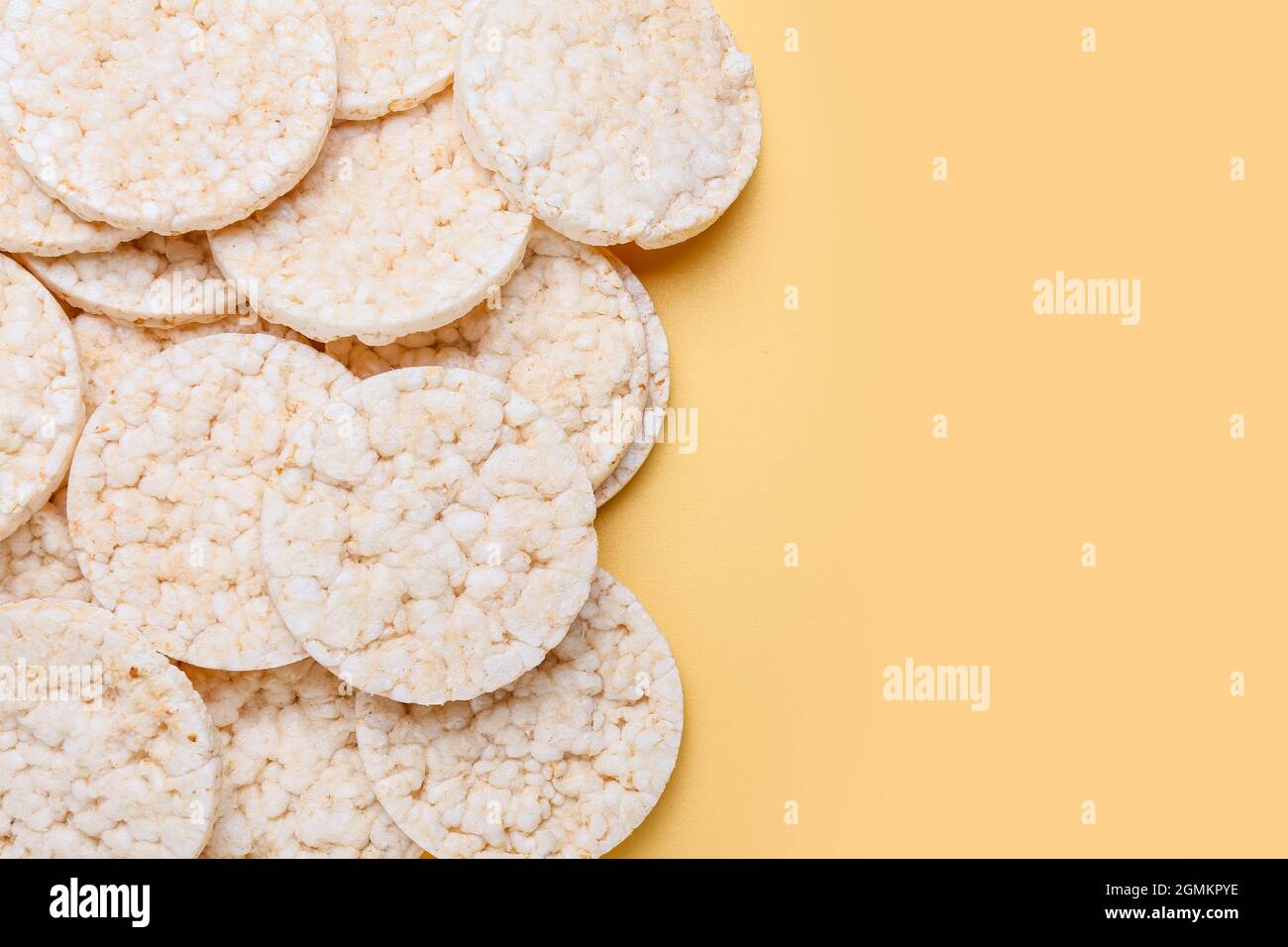 Puffed crispy rice crackers on color background Stock Photo - Alamy