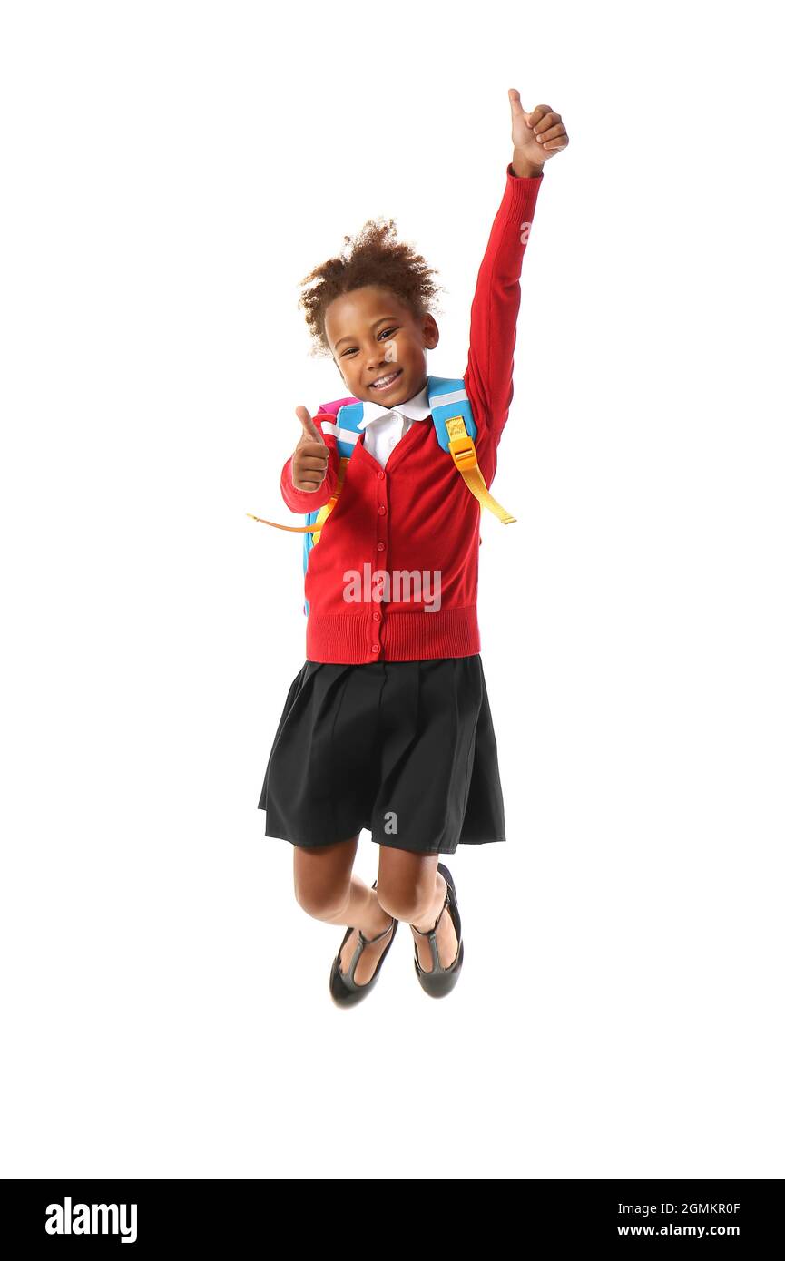 Jumping African-American schoolgirl showing thumbs-up on white ...