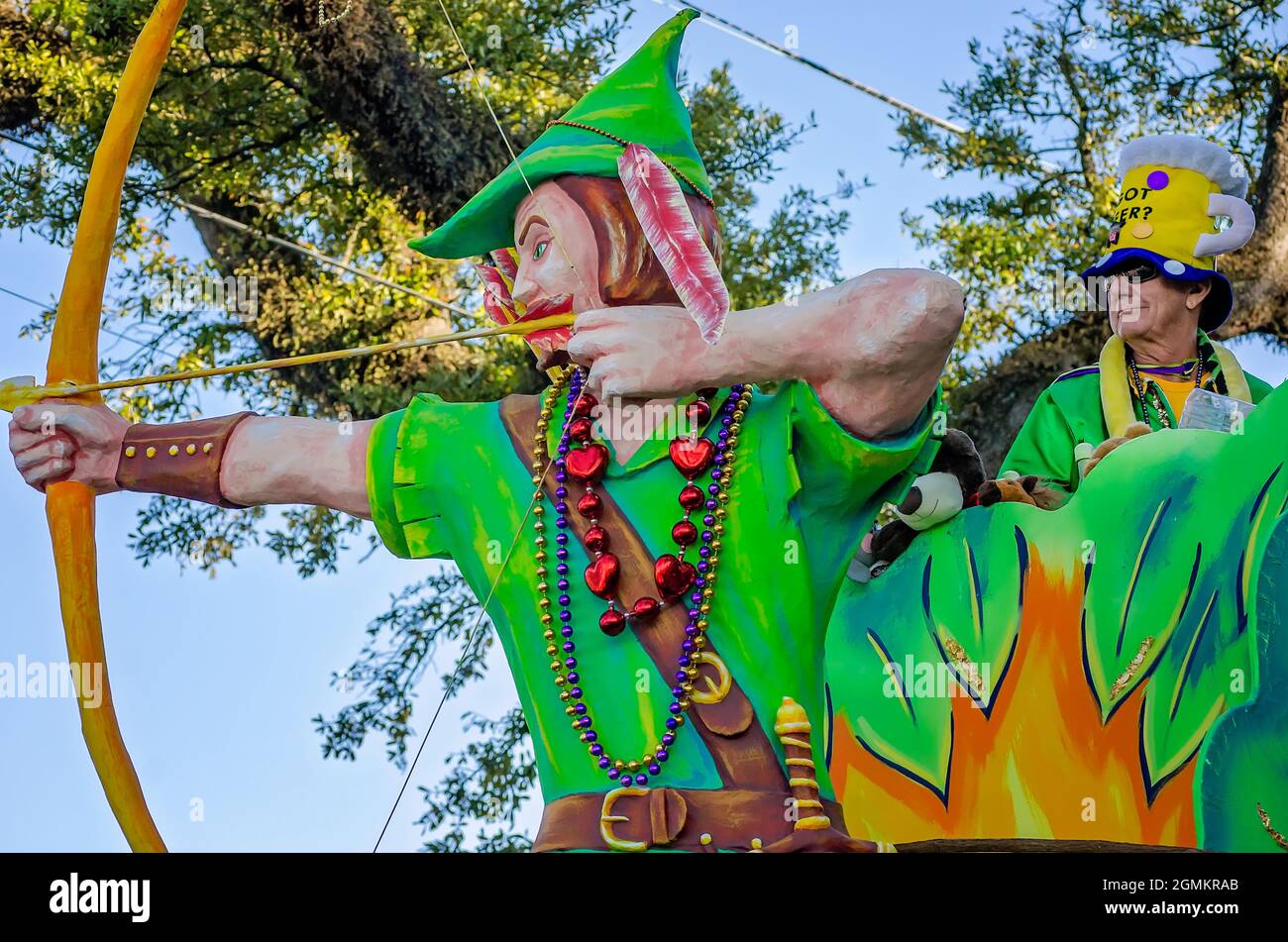 A Mardi Gras reveler rides a float with a Robin Hood theme during the ...