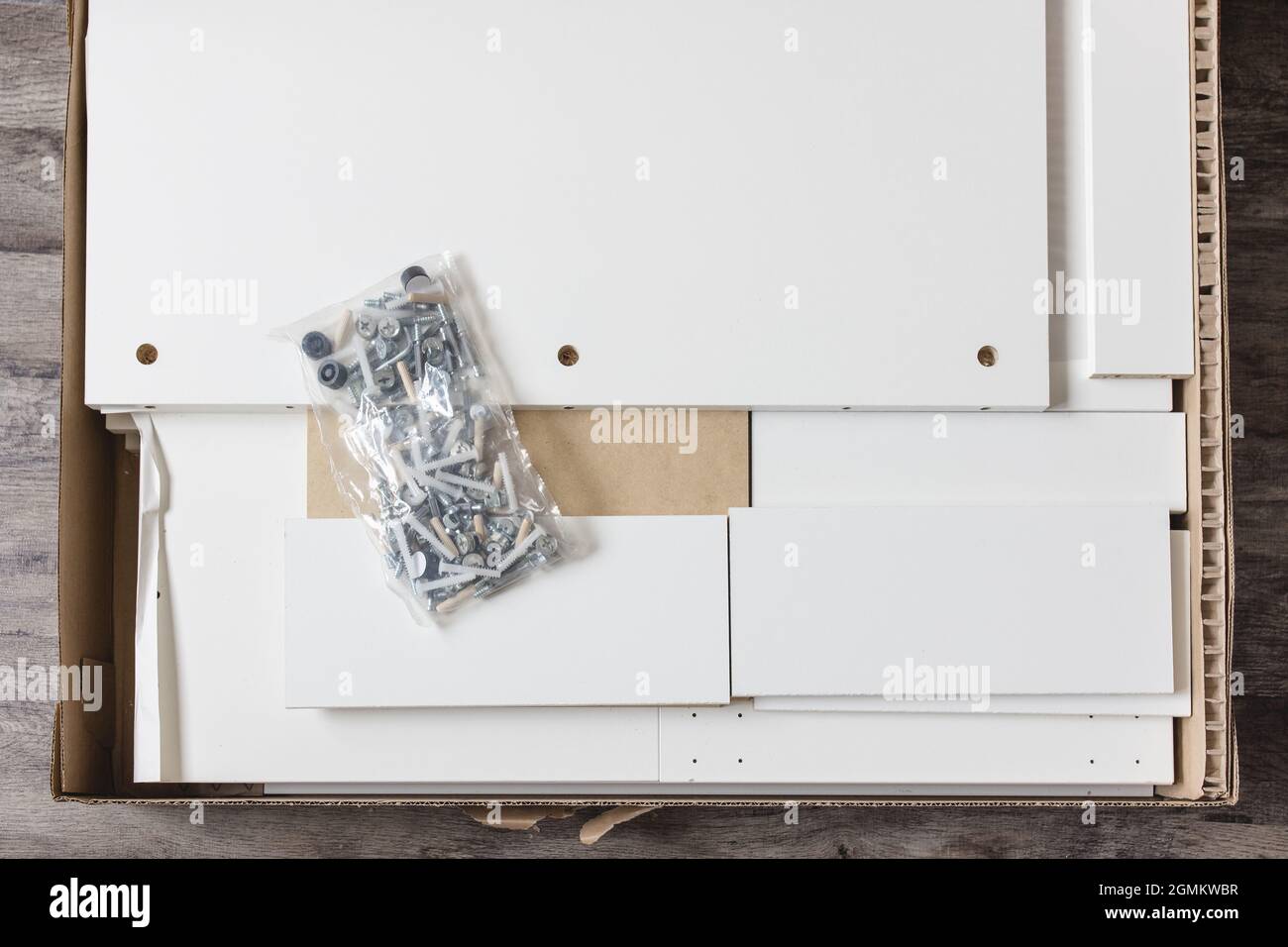 Box with furniture assembly parts on the floor Stock Photo - Alamy