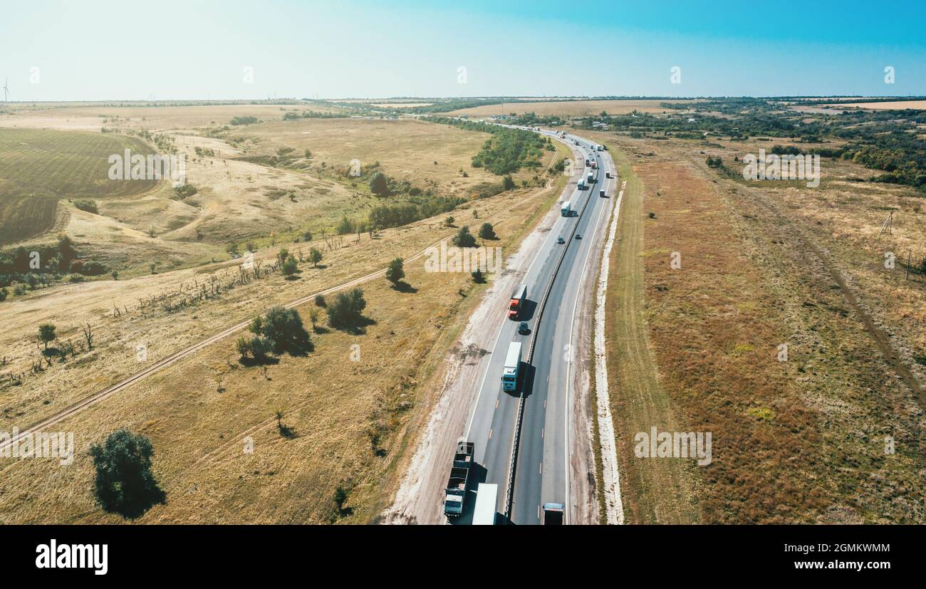 Logistics cargo transportation concept. Many freight cargo trucks drive ...