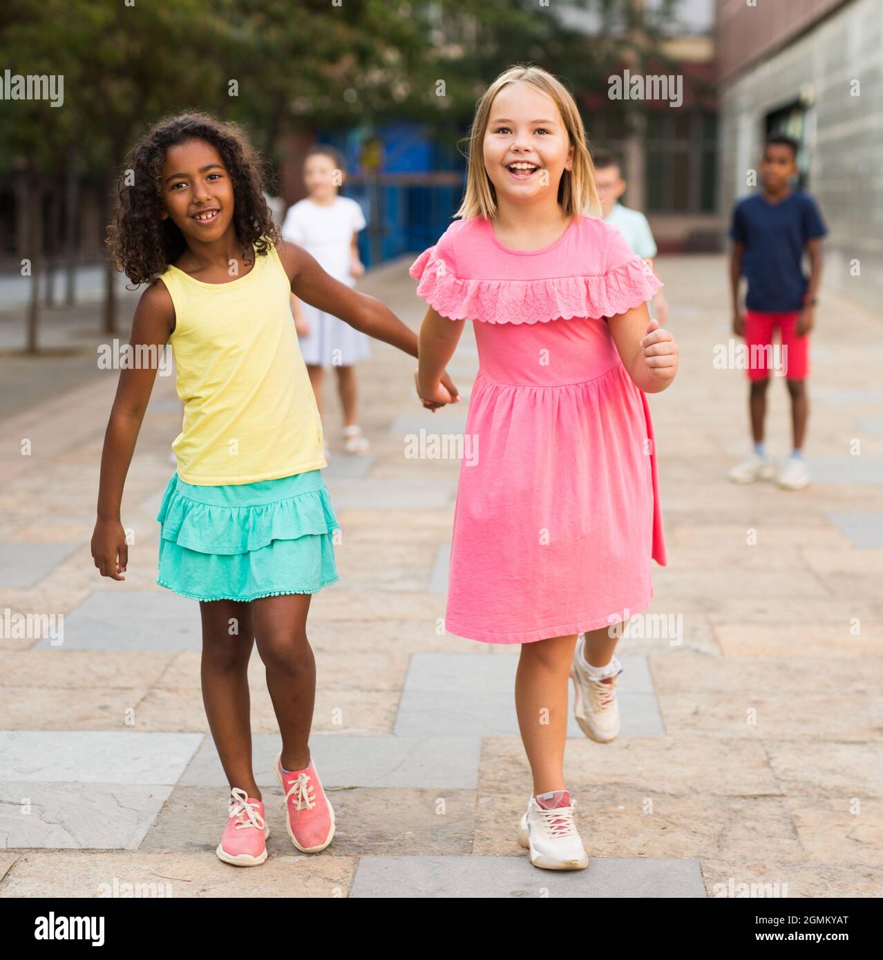 Two girls walking together outdoors Stock Photo - Alamy
