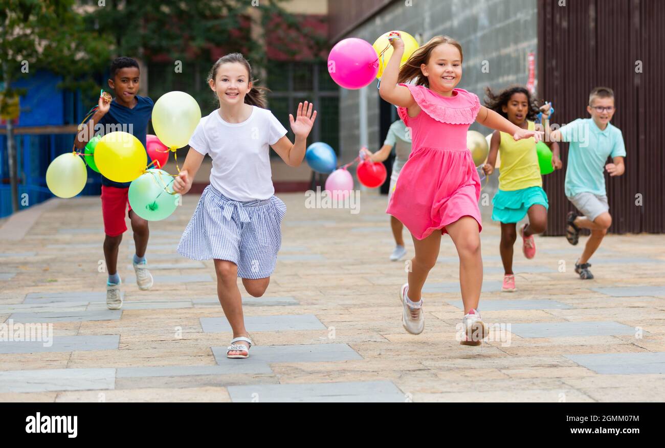 Boy girl colorful balloons running hi-res stock photography and images ...