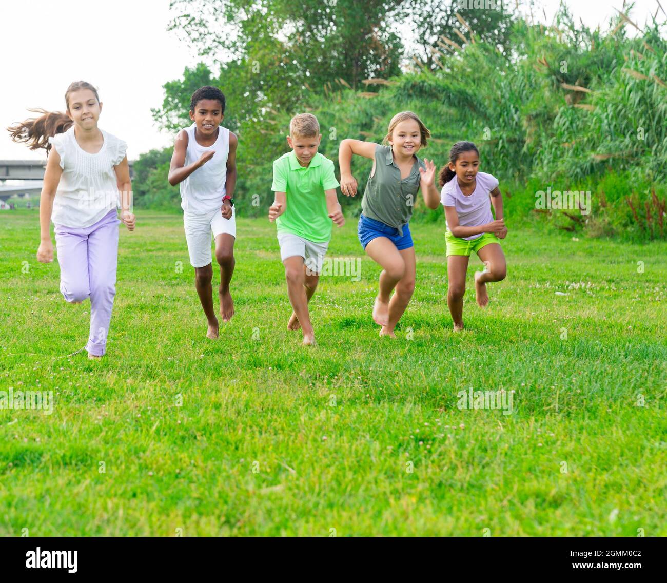 Barefoot kids running on green grass Stock Photo - Alamy