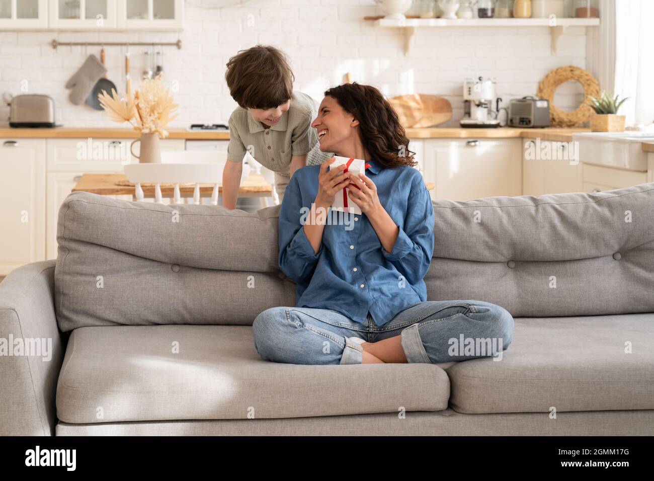 Little son make birthday surprise to mum greeting female parent with ...