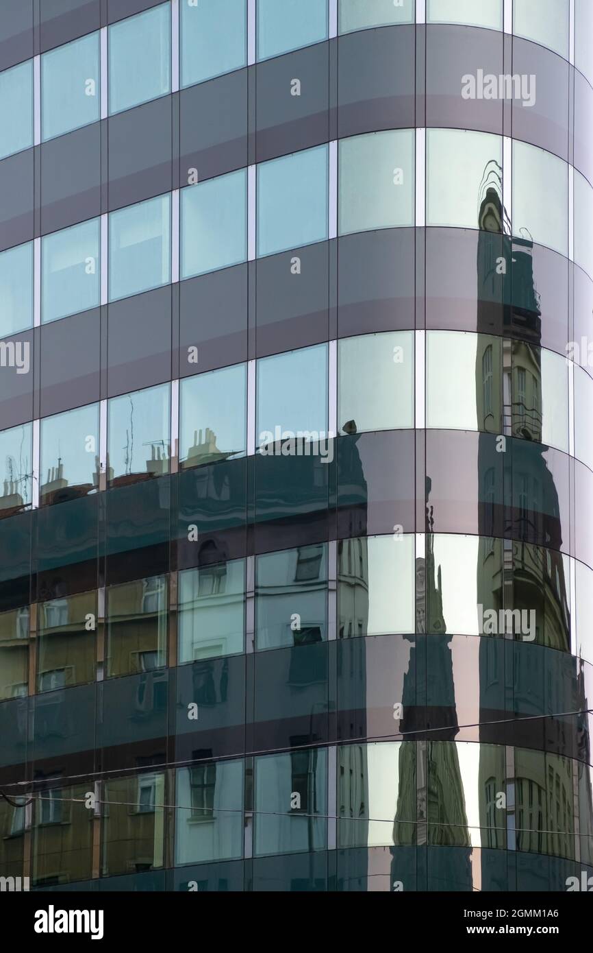 a European architecture reflecting in the mirror glass facade of a ...