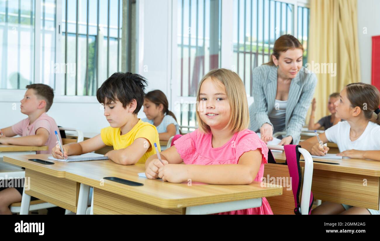 Kids sitting in classroom Stock Photo - Alamy